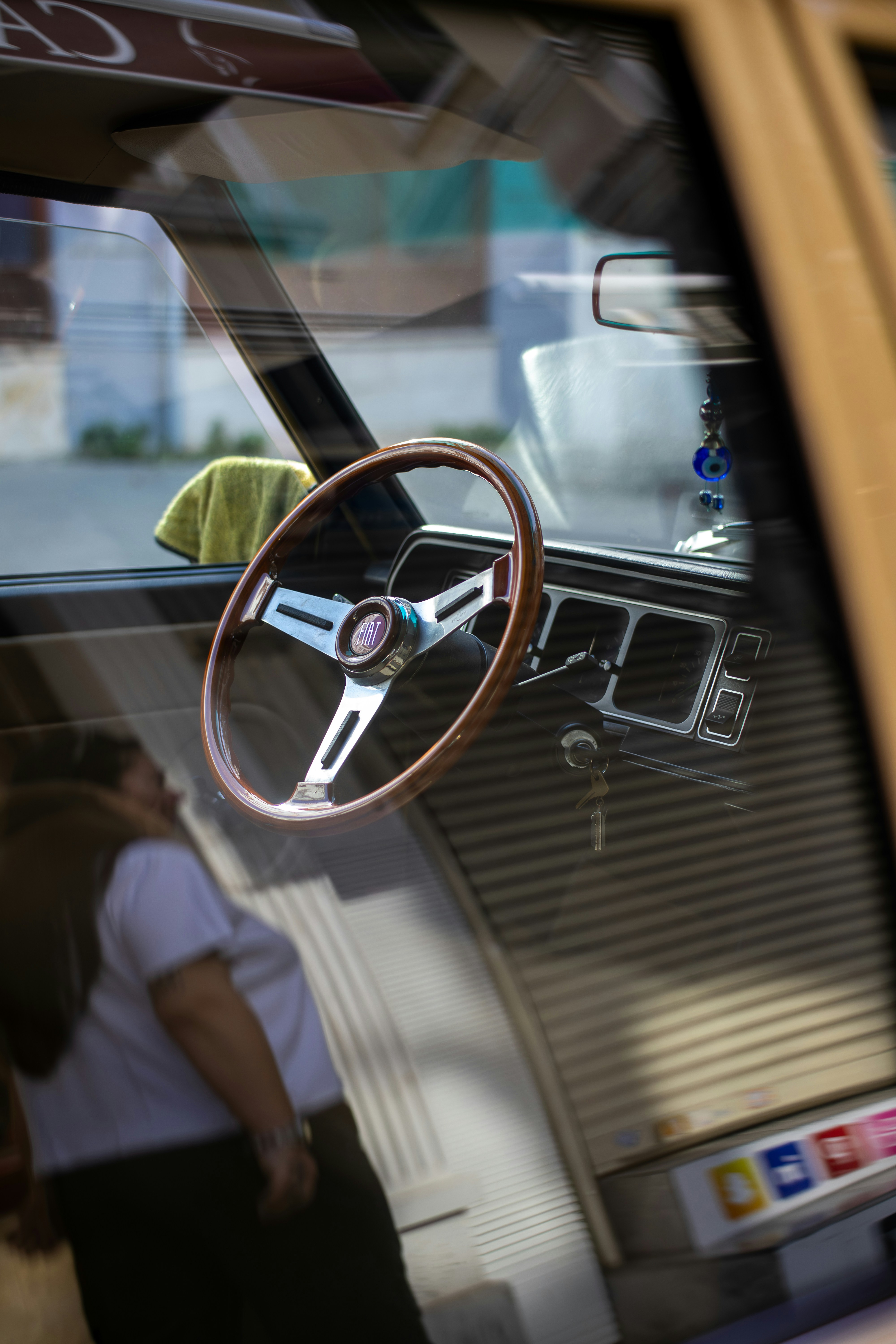 Sunlit Vintage Steering Wheel: A Quiet Glimpse Inside a Classic Car