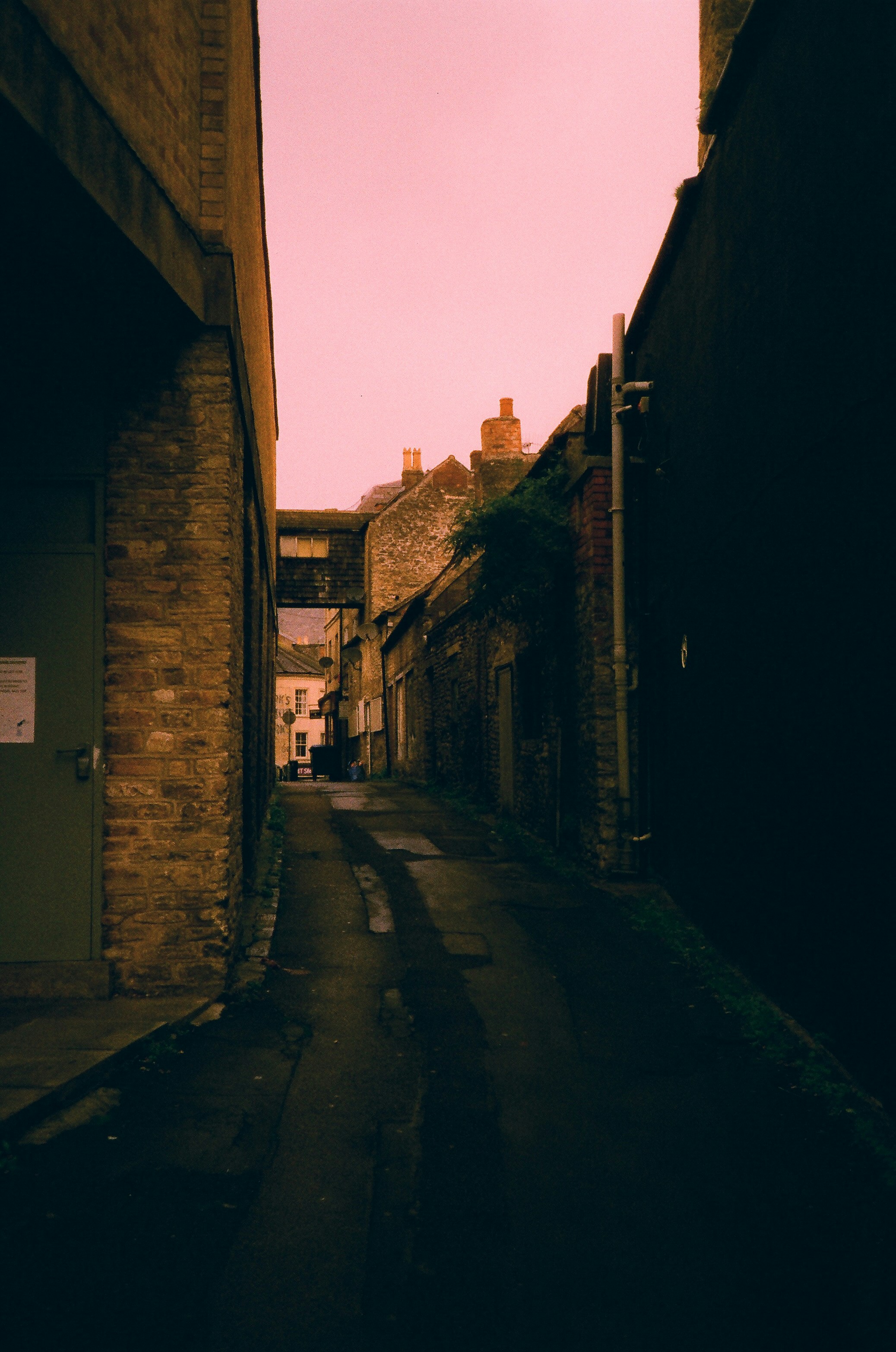 Narrow alleyway between old buildings under pink sky photo – Free Door ...