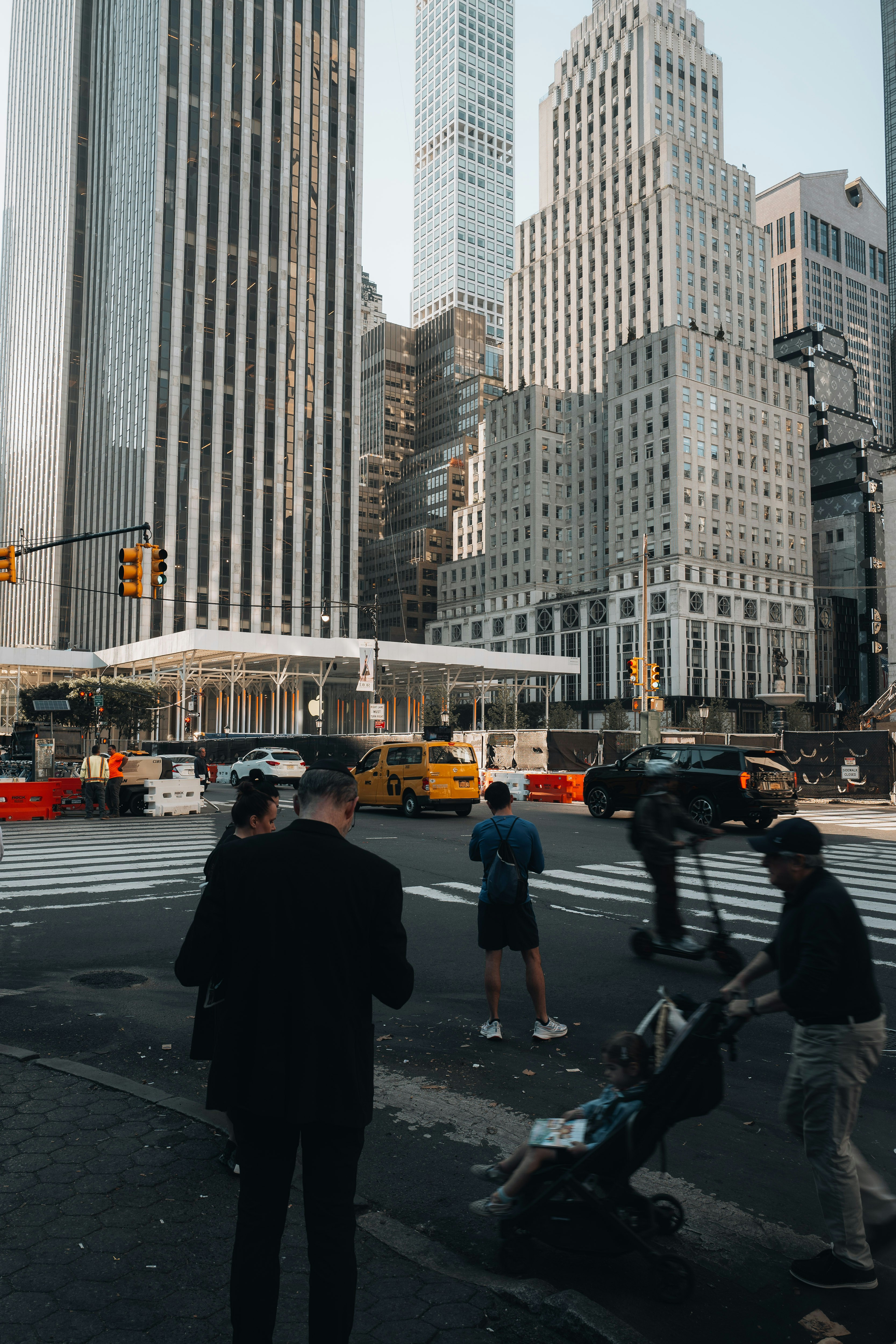 Crosswalk Confluence: Pedestrians, Taxis, and Towering Facades