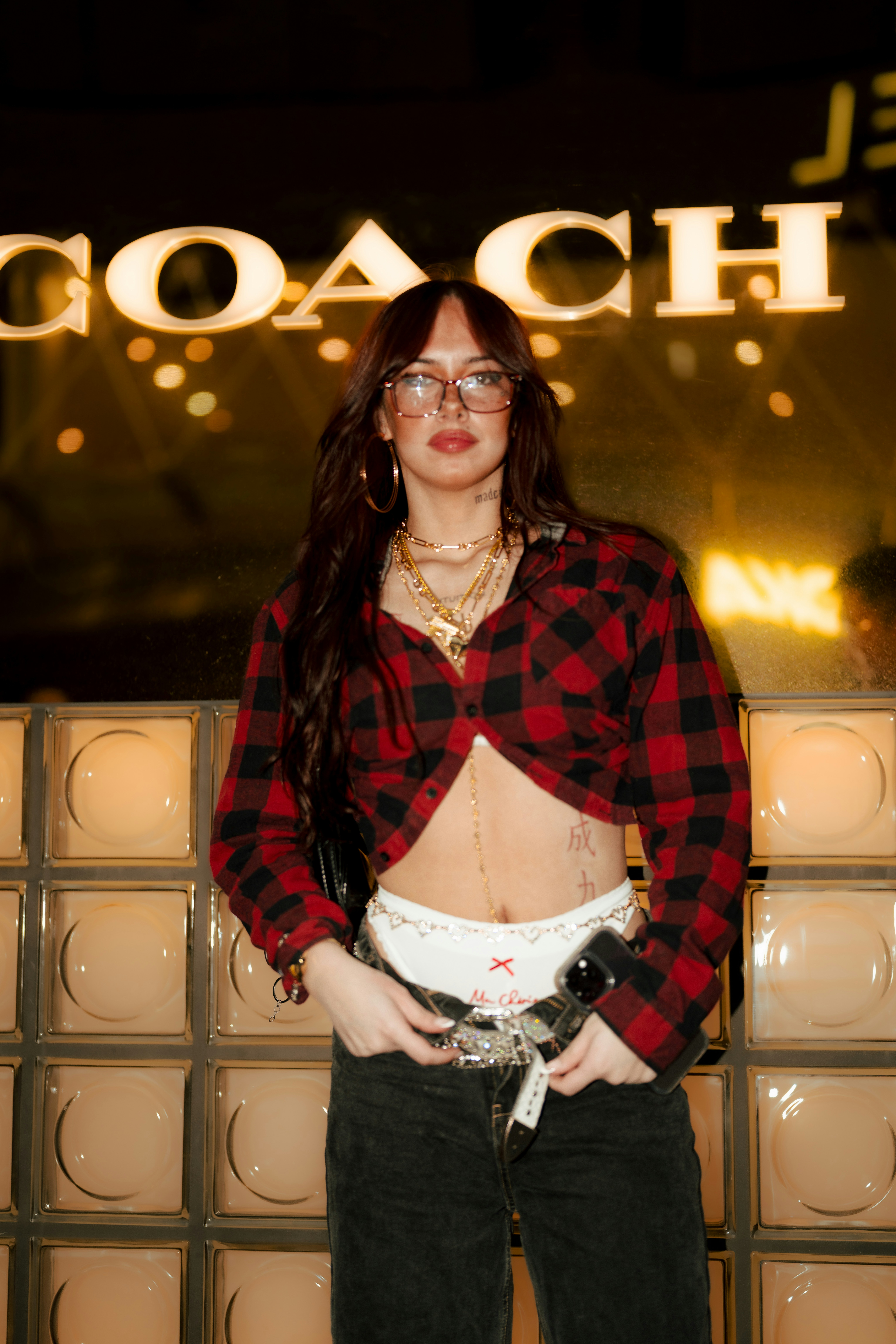 Neon Glow Portrait: Plaid, Gold Chains, and a Coach Sign