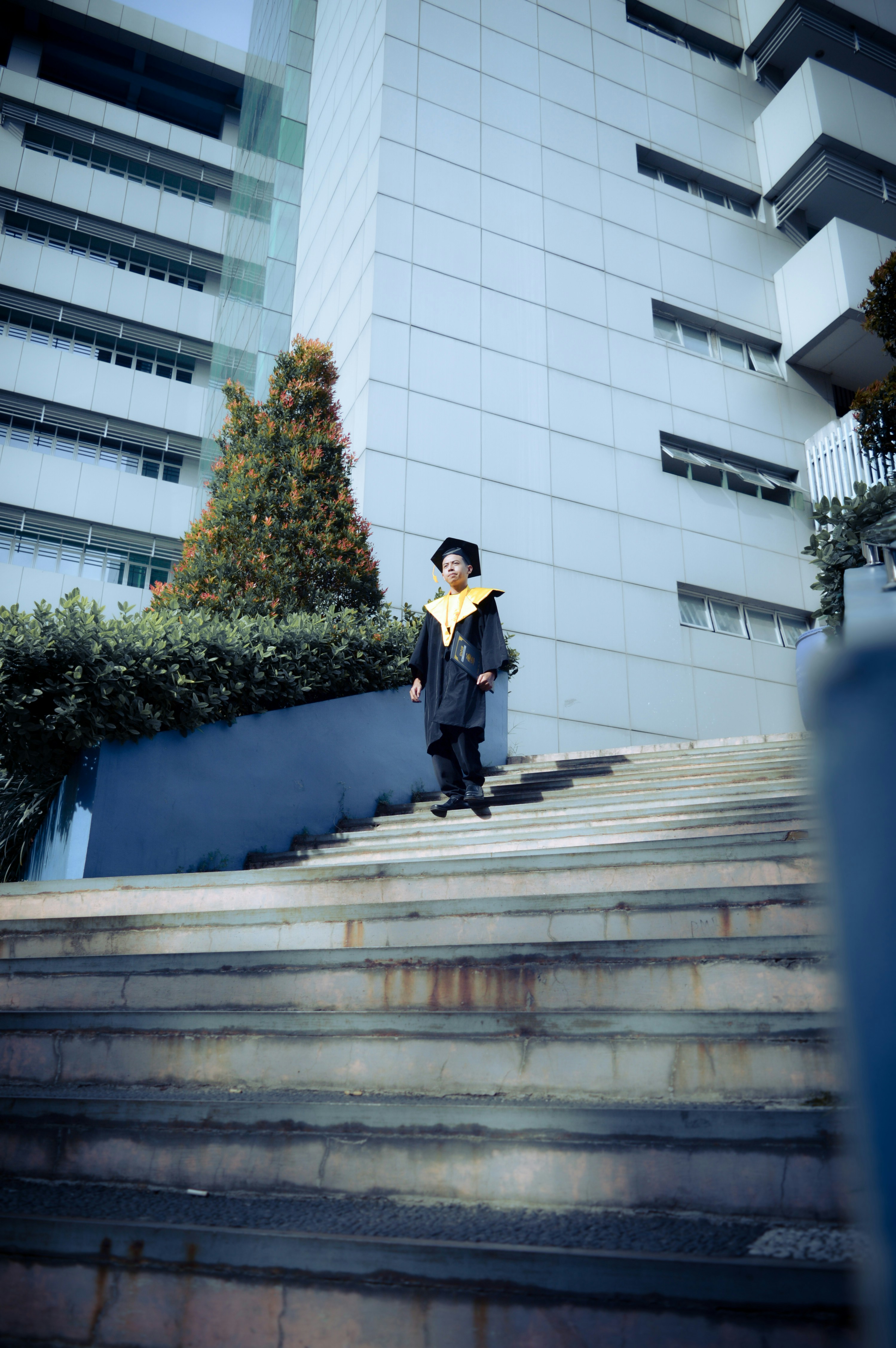 Graduation on the Steps: A Quiet Moment Before Departure