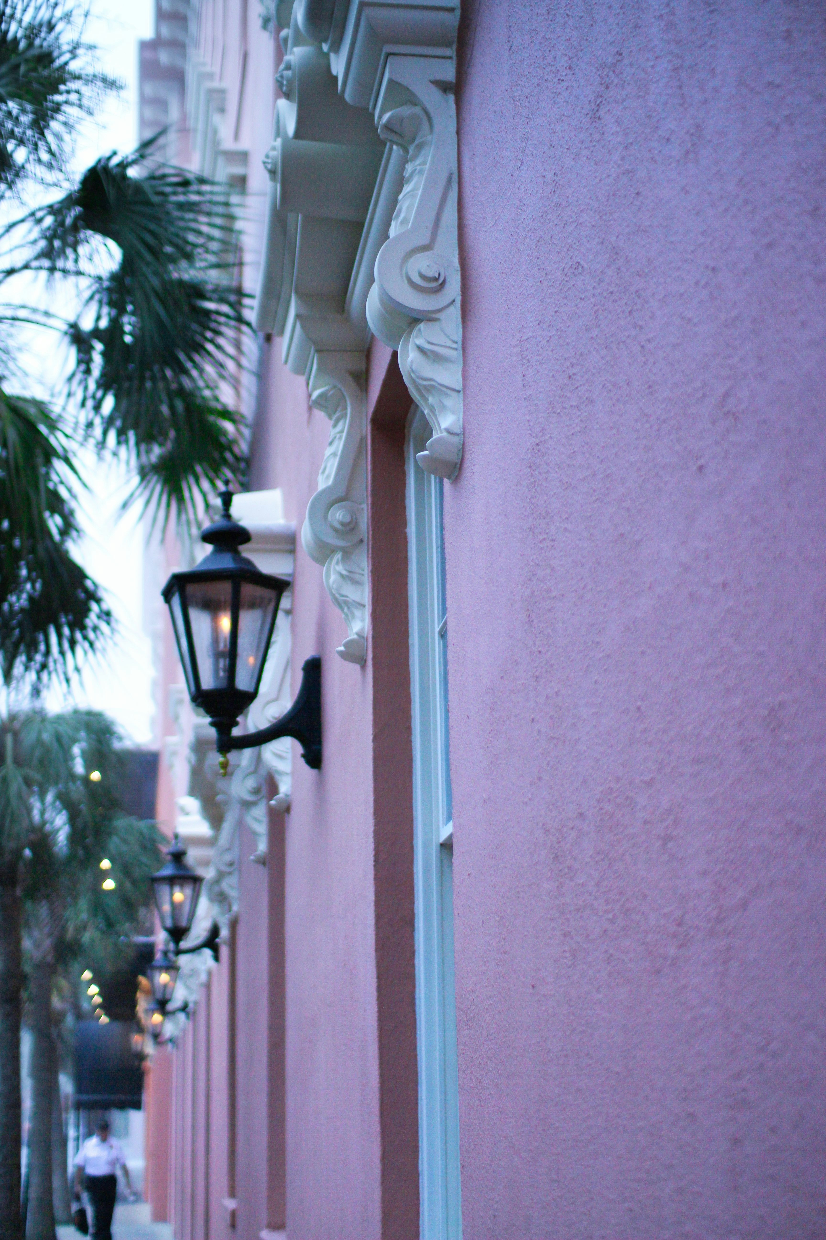 Lantern Row Along a Blush Pink Facade