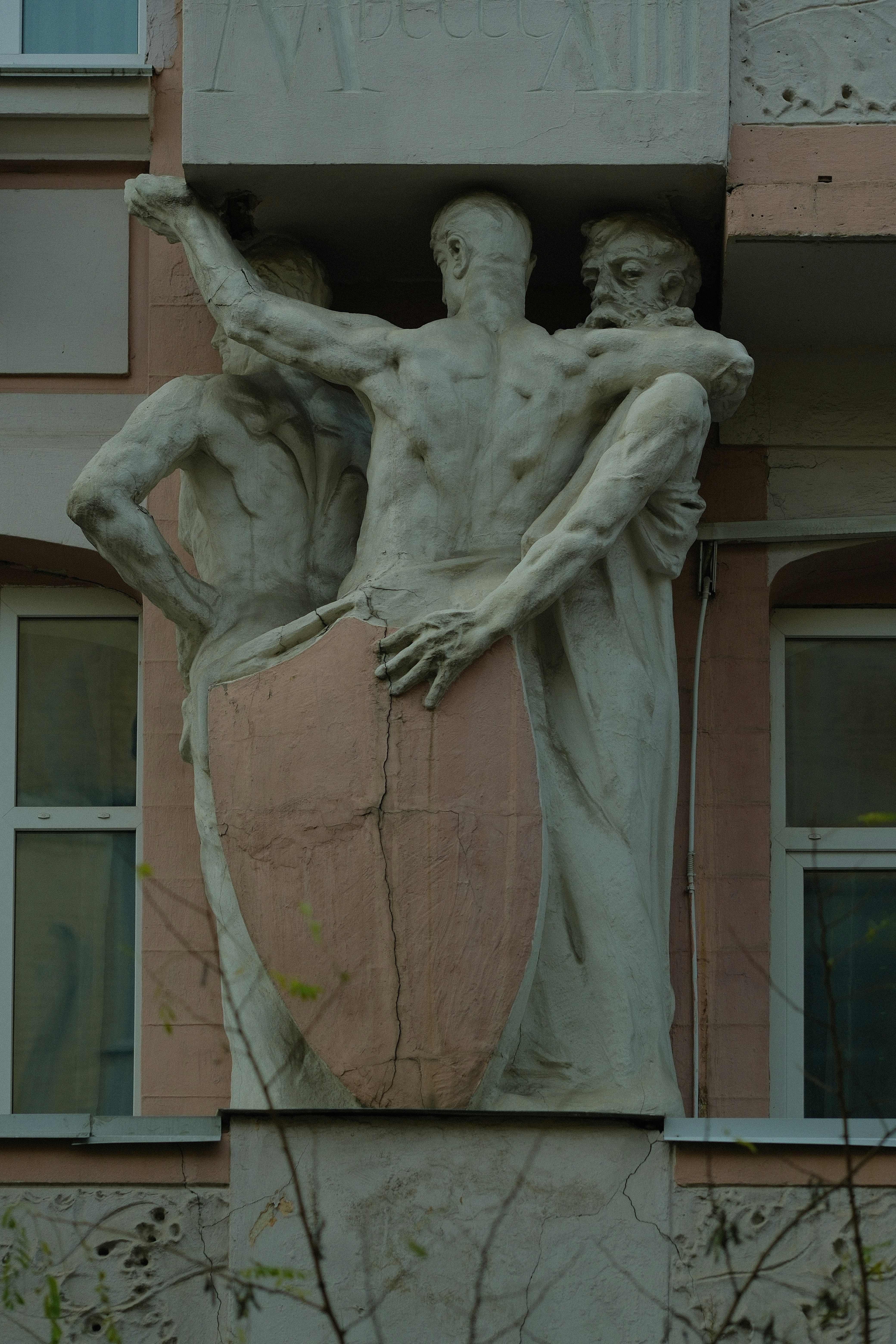 Three-Shouldered Vigil: Marble Figures Embrace a Shield Beneath a Pale Façade