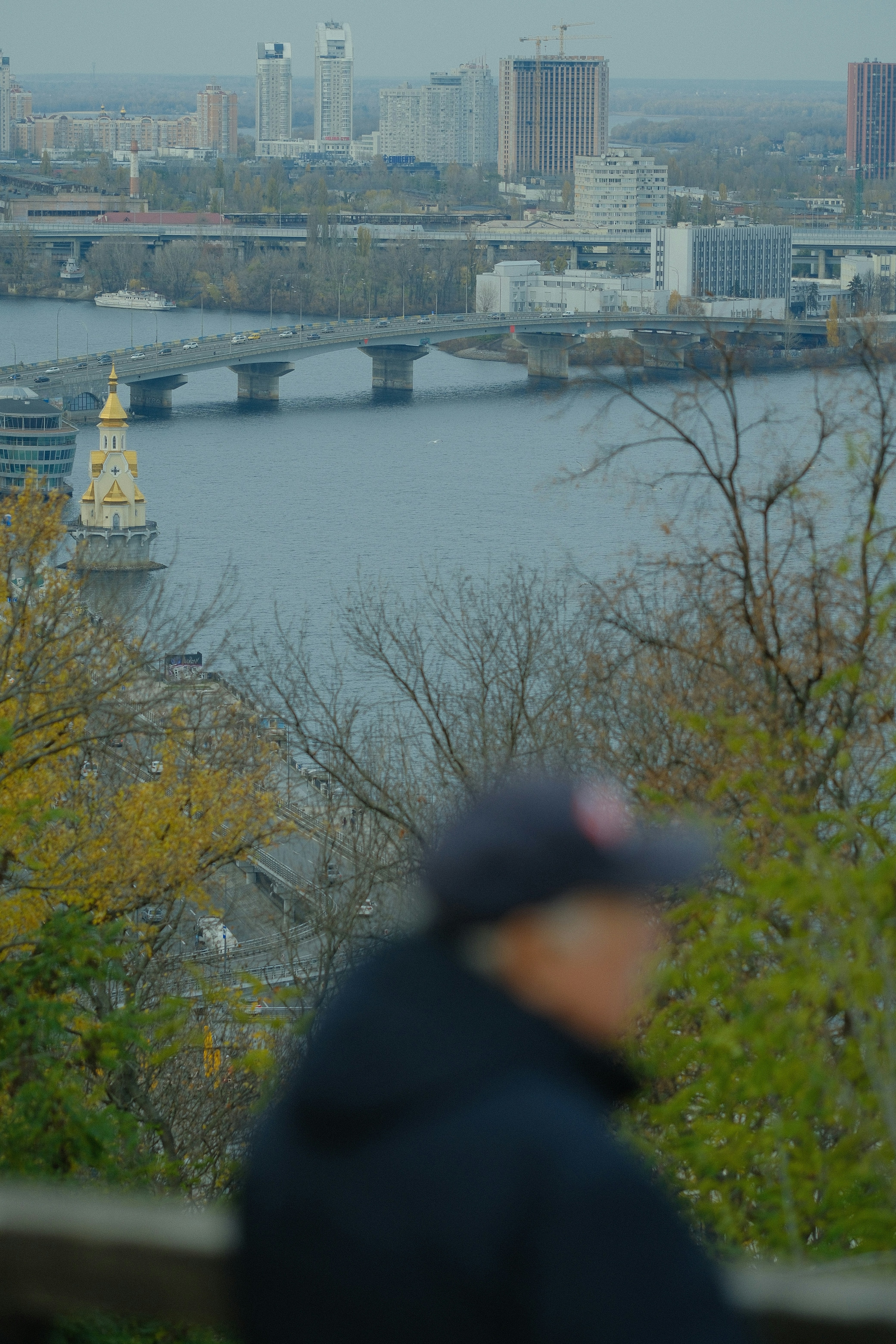 Overlooked River City: Golden Clock Tower with Urban Bridge Span