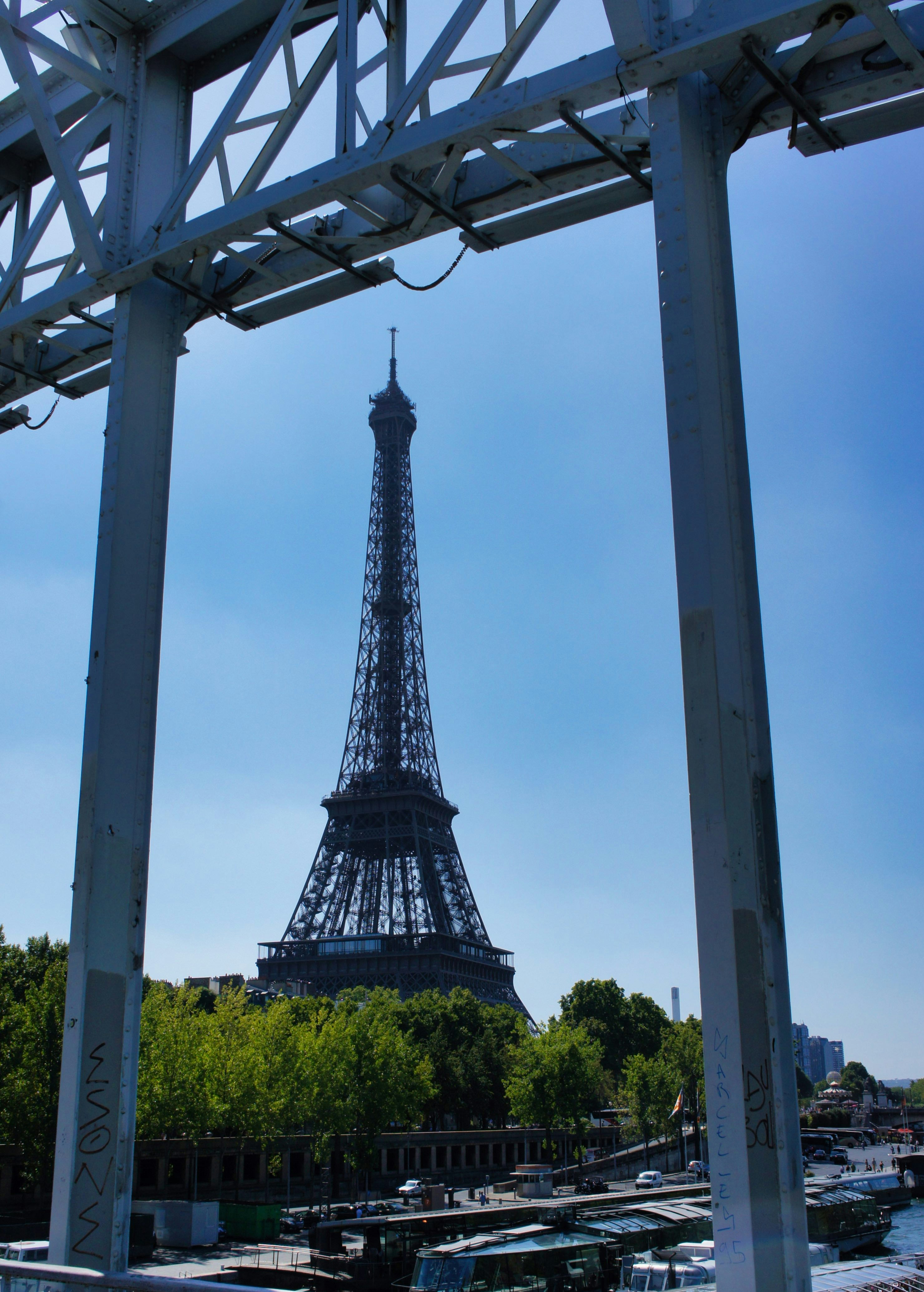 Eiffel Tower Framed by Crossing Steel Arches Over the Seine