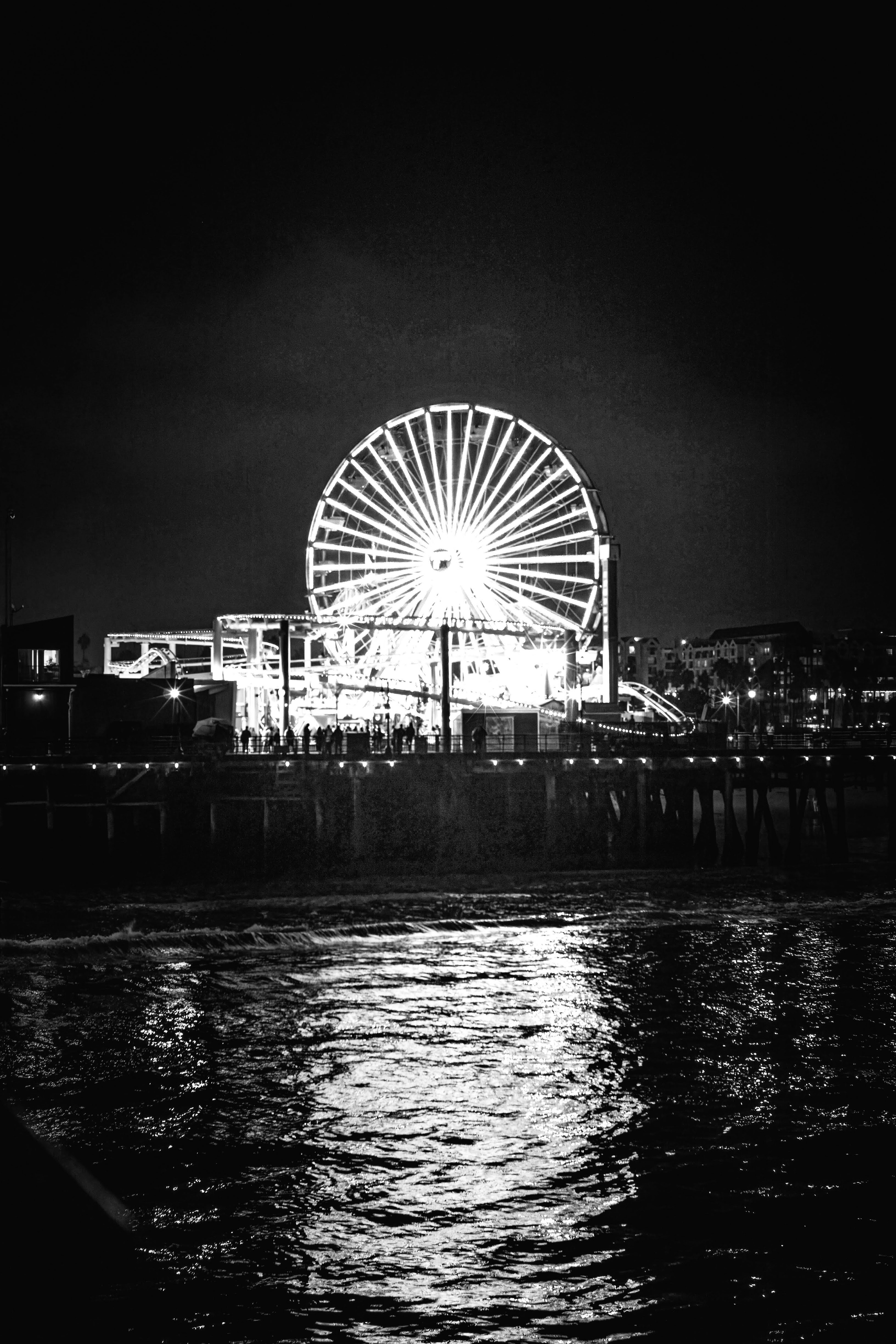 Luminous Ferris Wheel on a Moonlit Pier