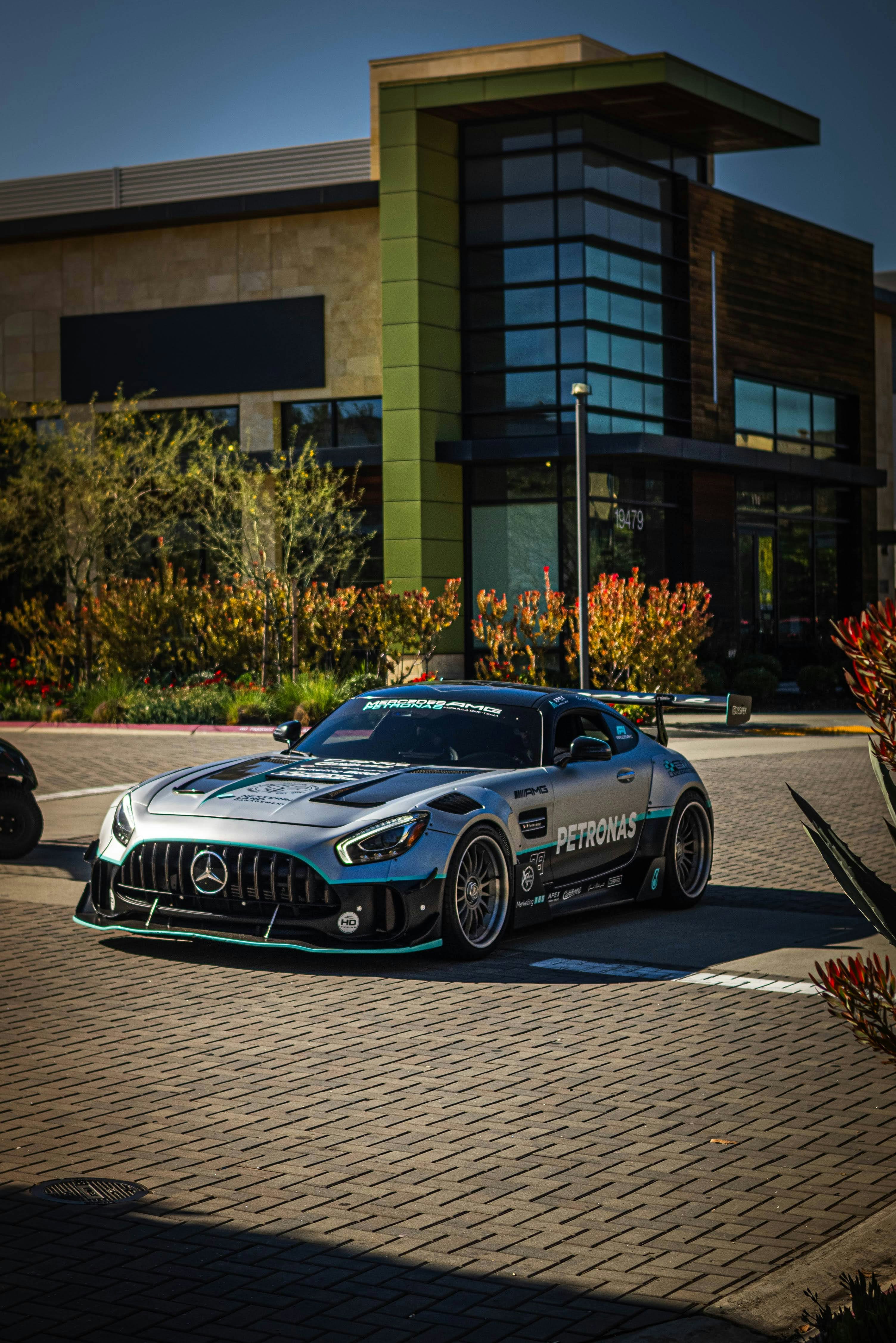 Low-Slung Mercedes GTR Beast in Front of Modern Office