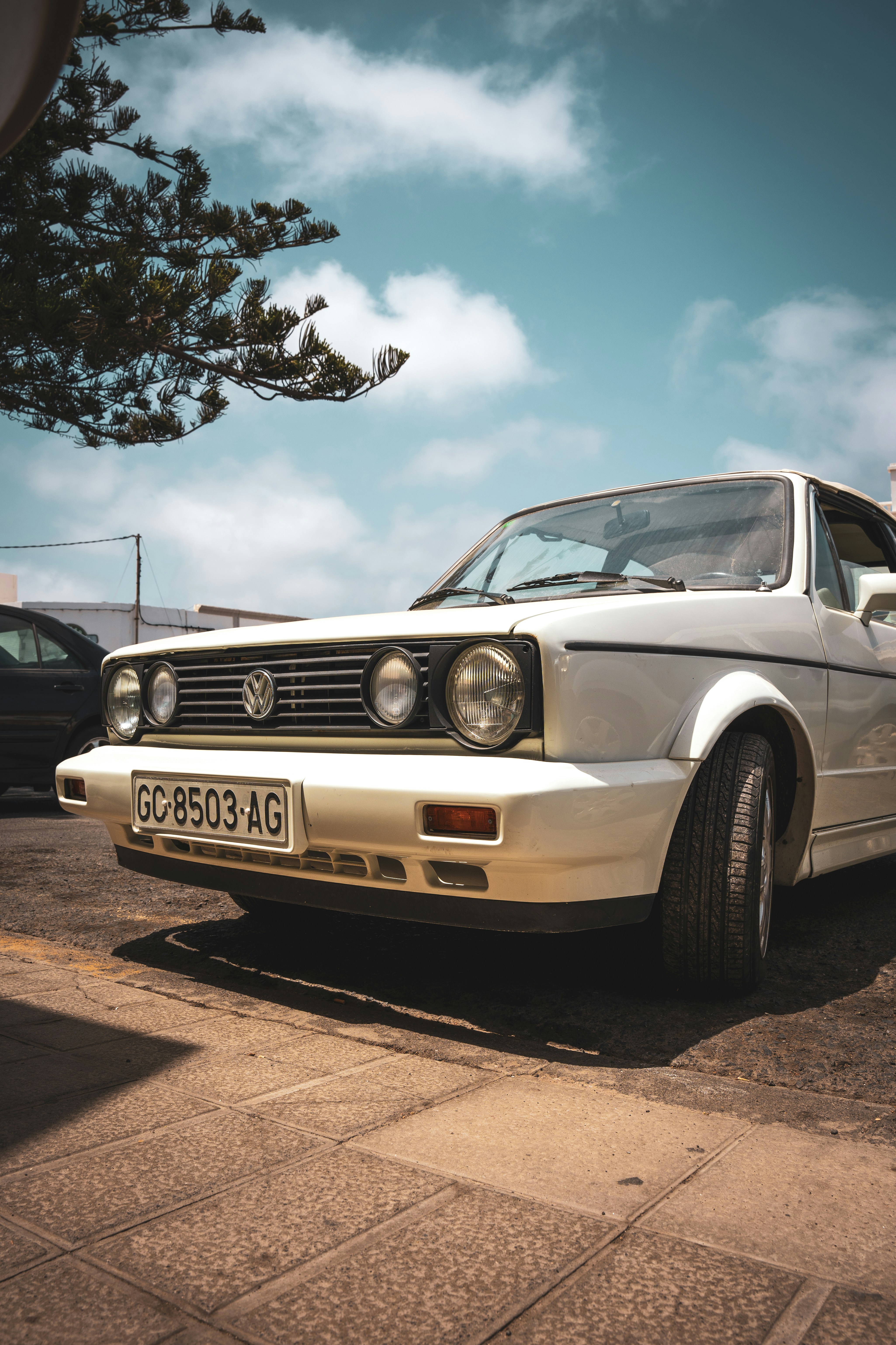 Low-Angle Portrait of a White VW Golf Mk2 on a Sunlit Street