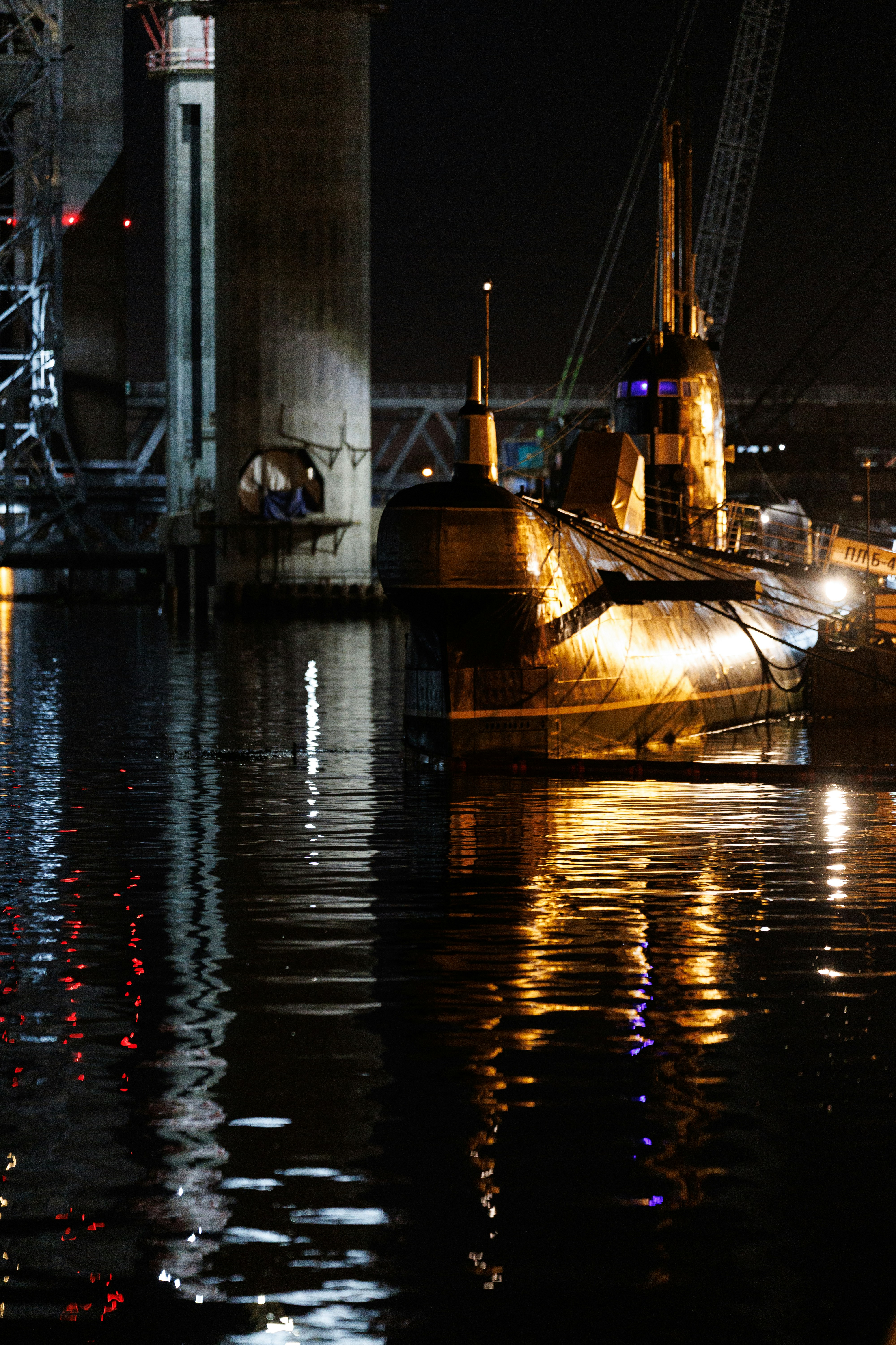 Amber-lit Tug at a Quiet Dock: Night Reflections on Industrial Water