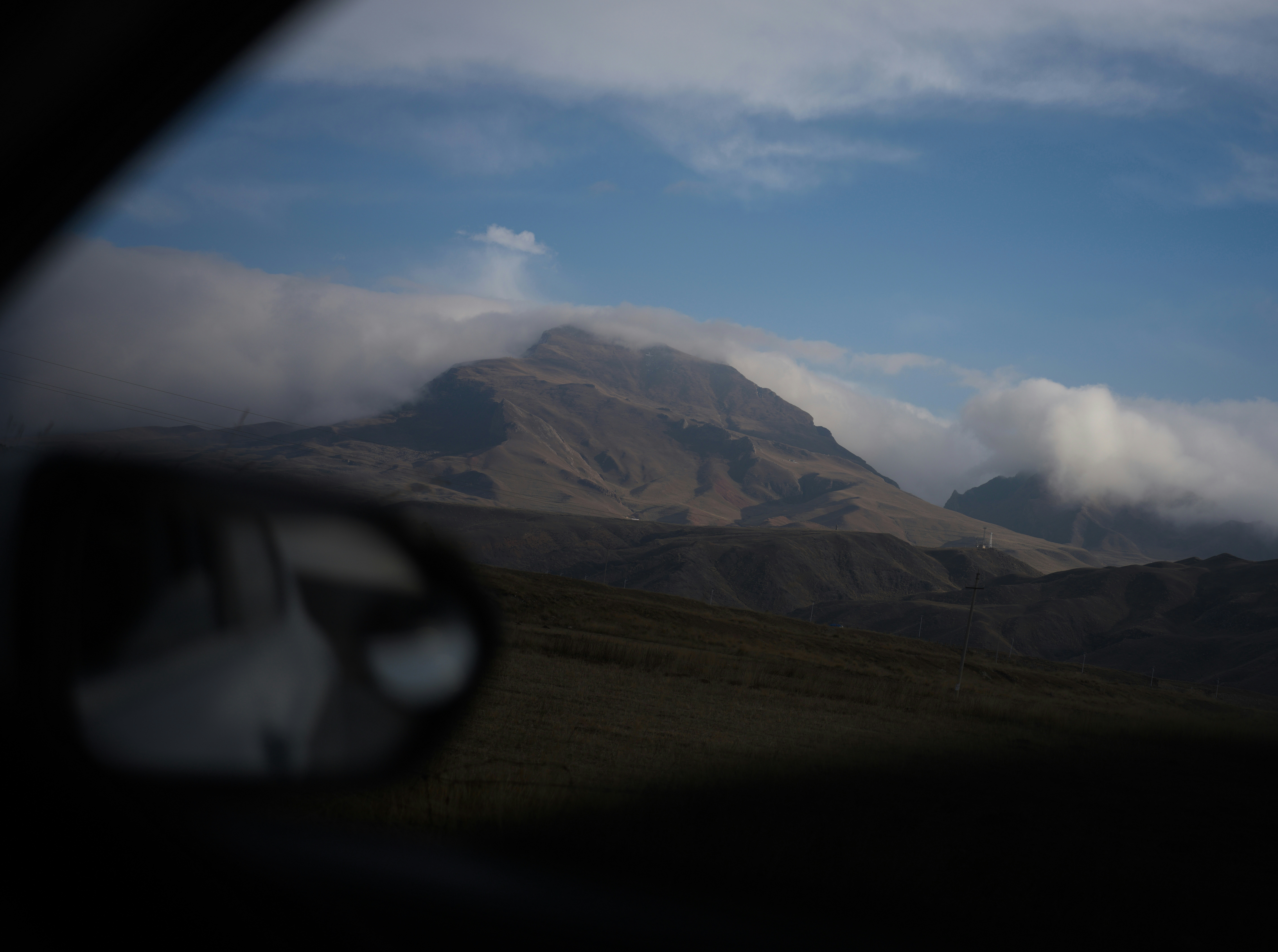 Cloud-veiled Summit Framed by a Moving Window