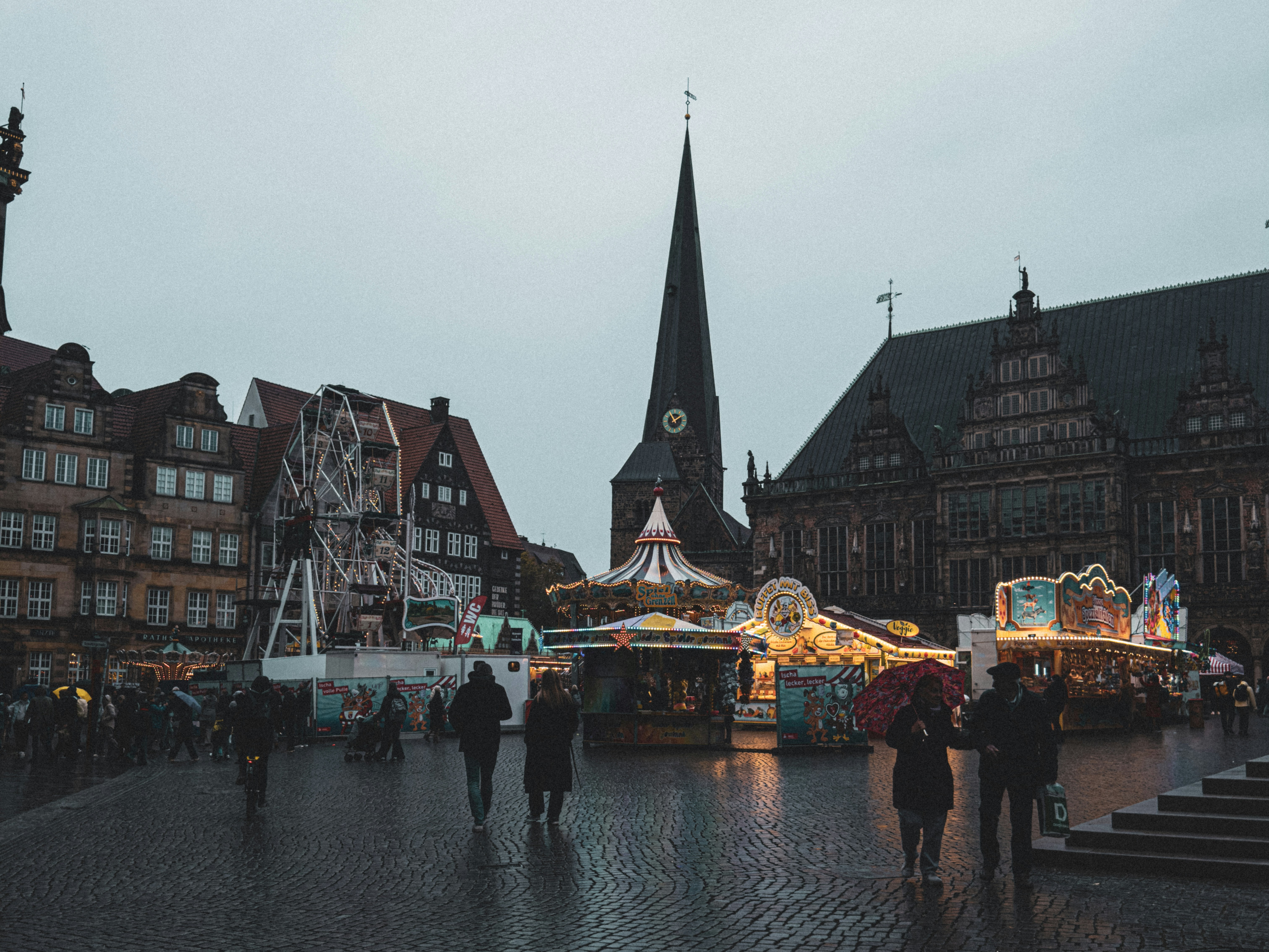 Carousel Lanterns Under a Medieval Spire: Dusk in a Historic City Square