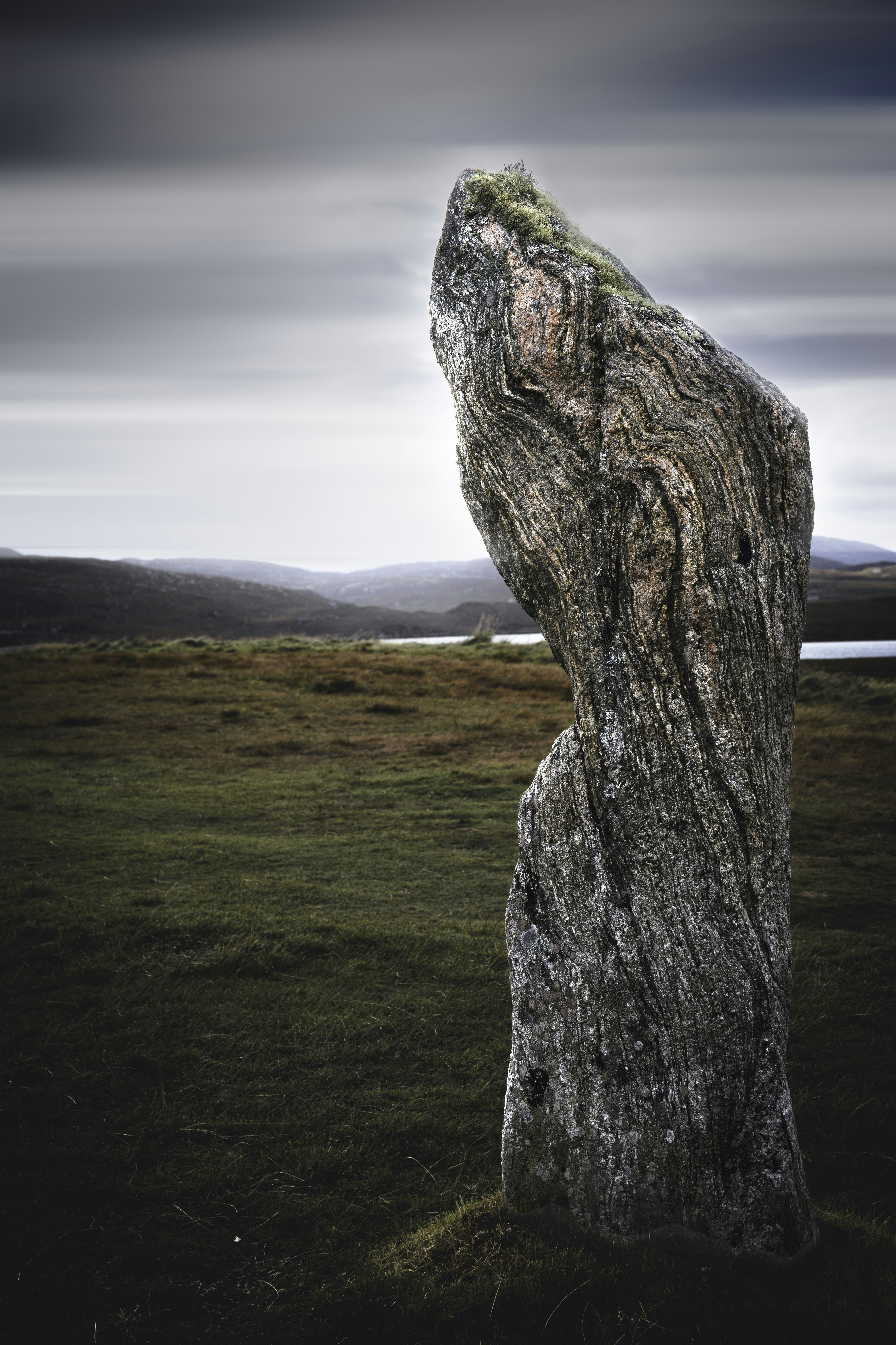 Sentinel on the Moor: A wind-worn standing stone amid a muted horizon