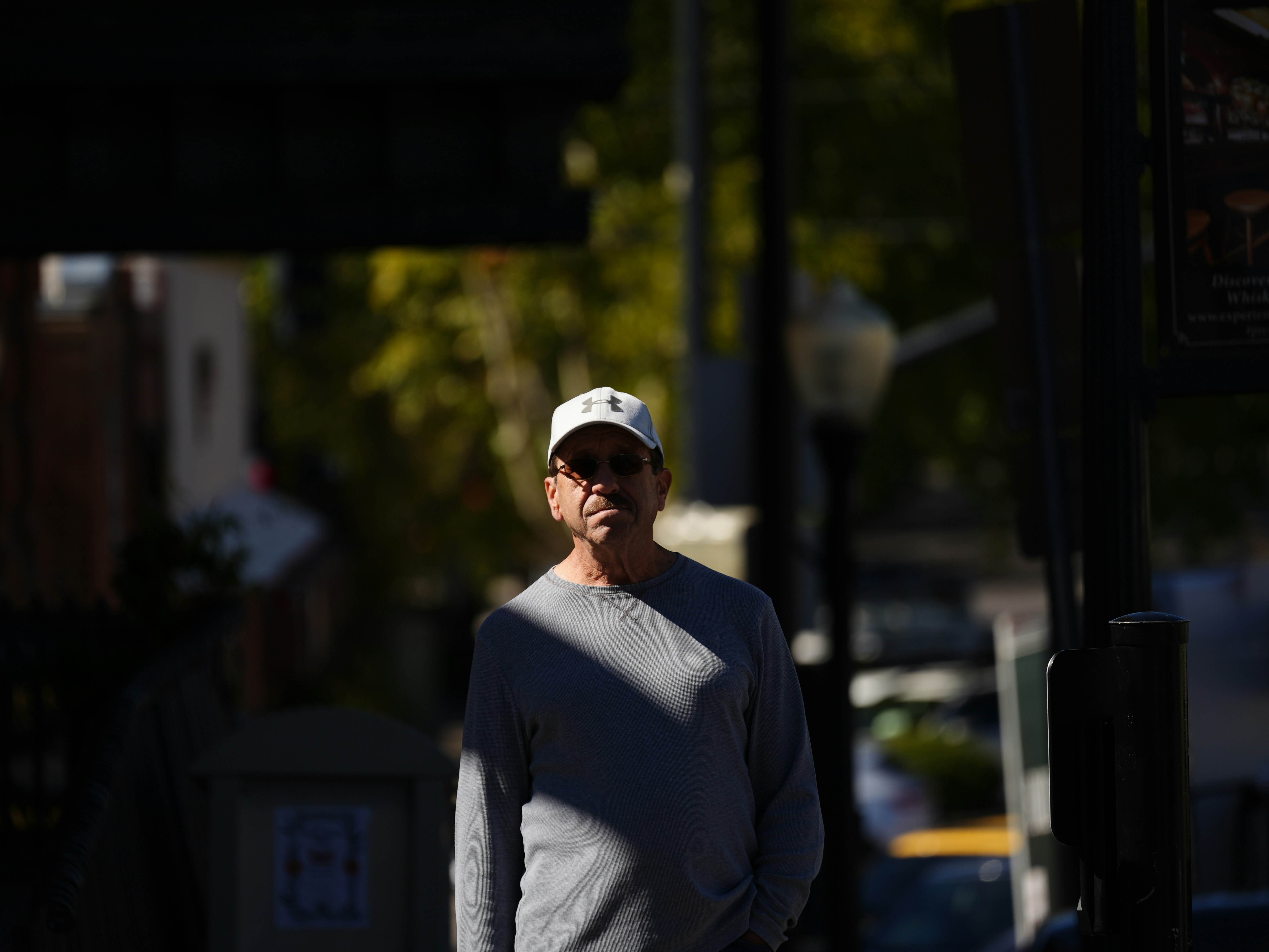 Dappled Light, Quiet Gaze: Portrait Under an Urban Canopy