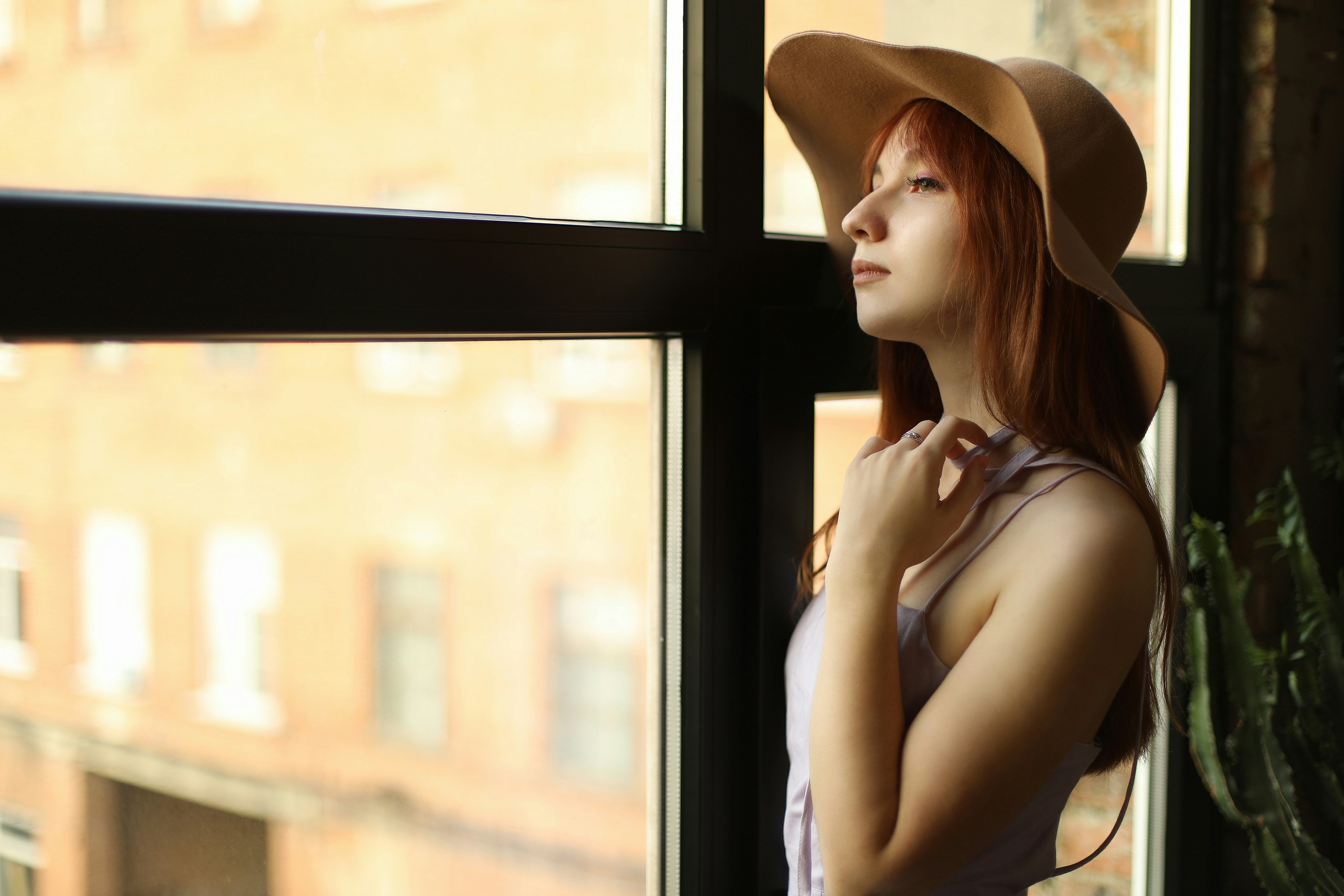 Amber-Hour Window Portrait: Quiet Gaze in a Wide-Brim Hat
