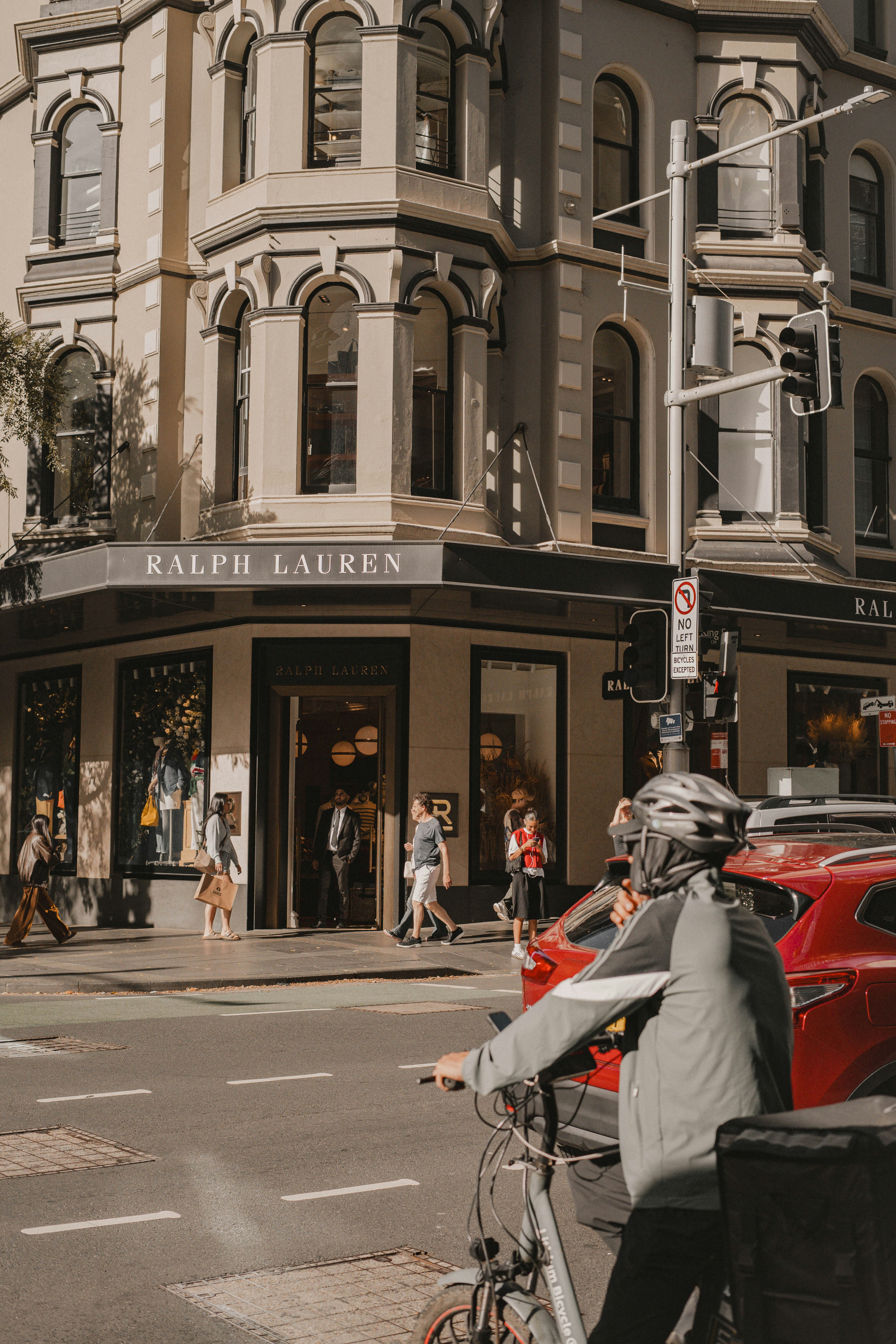 Sunlit Corner Couture: City life frames a Ralph Lauren flagship