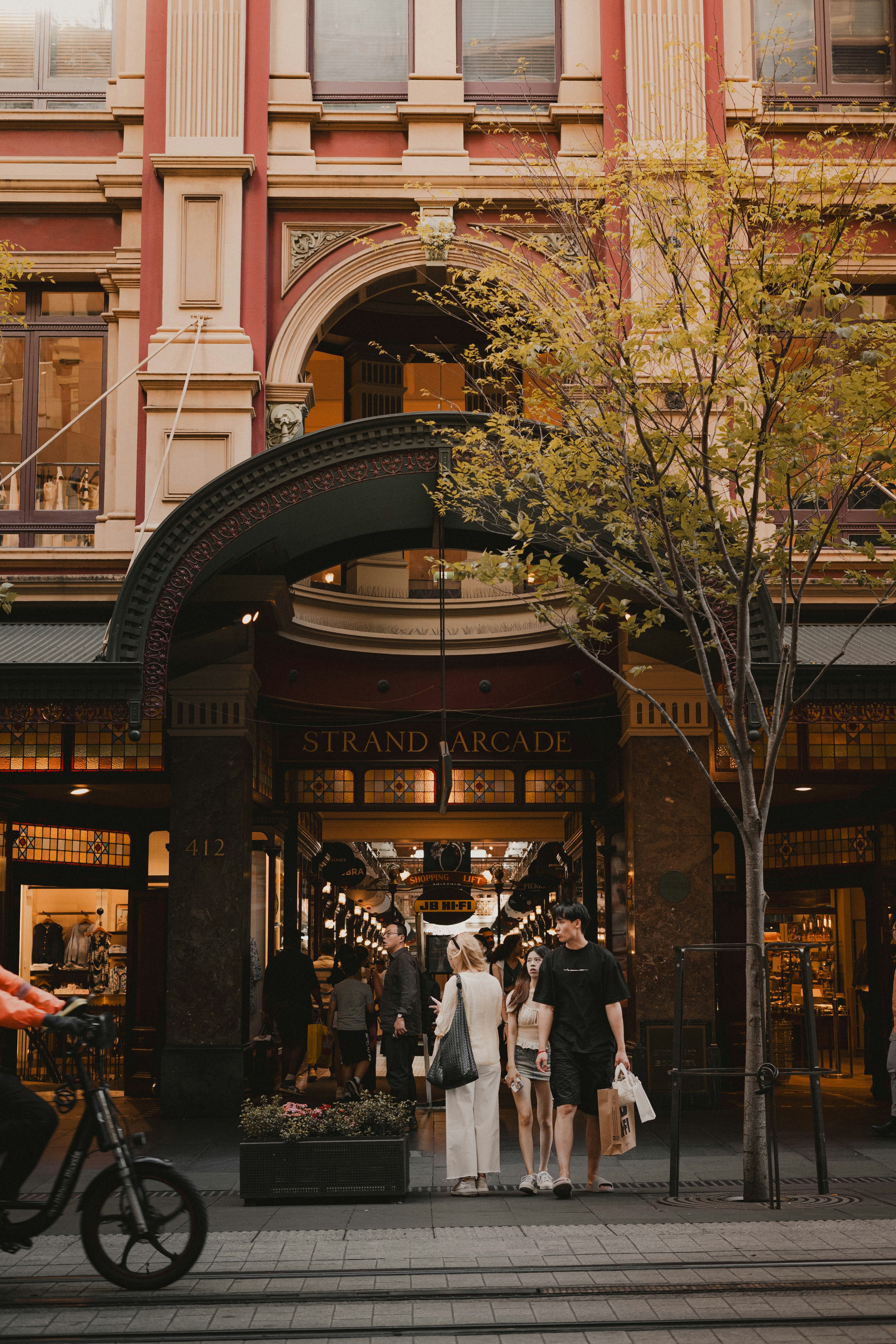 Strand Arcade Archway in Autumn Light: Pedestrians Beneath a City Facade