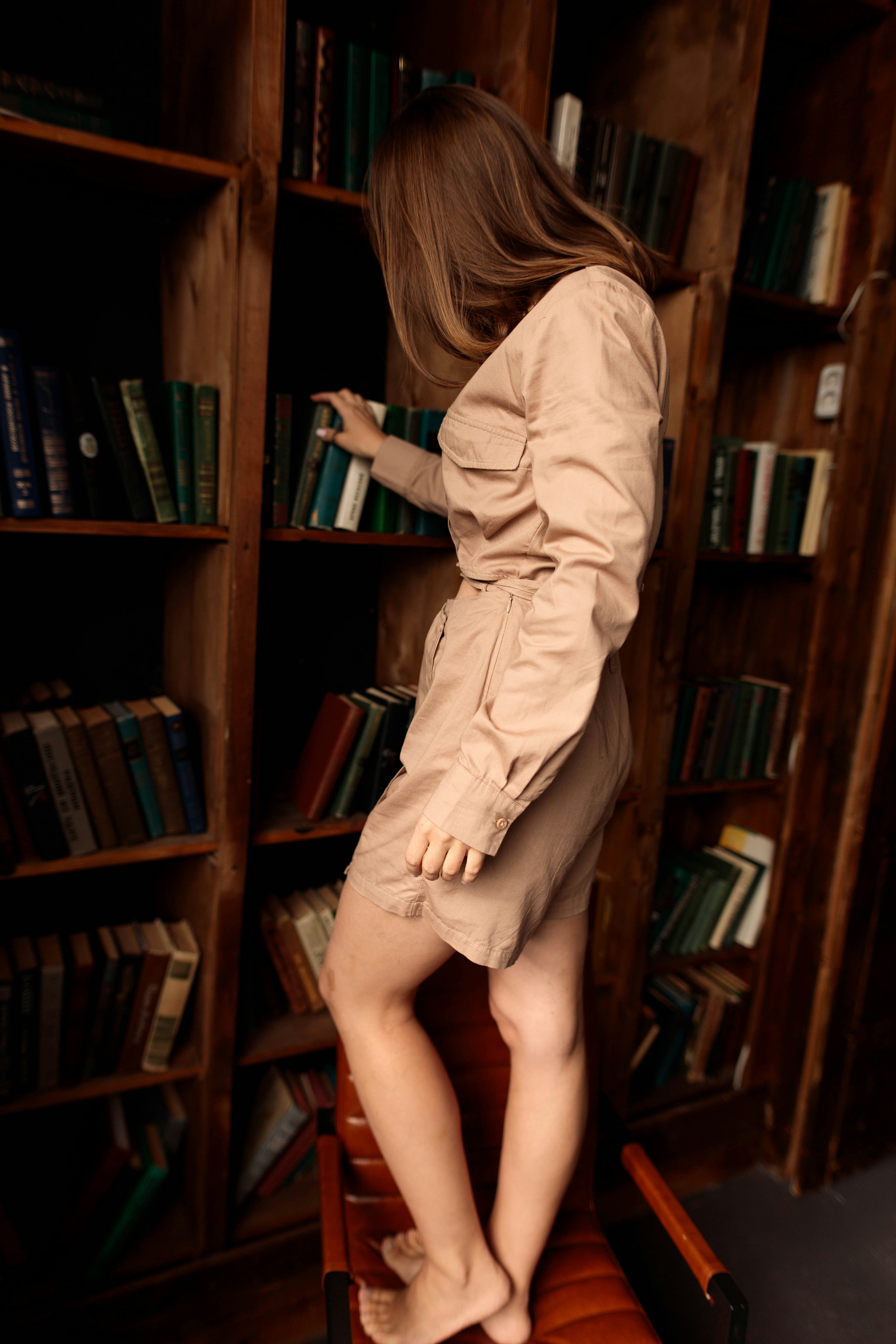Barefoot in the Library Aisle: A Quiet Moment Among Wooden Shelves