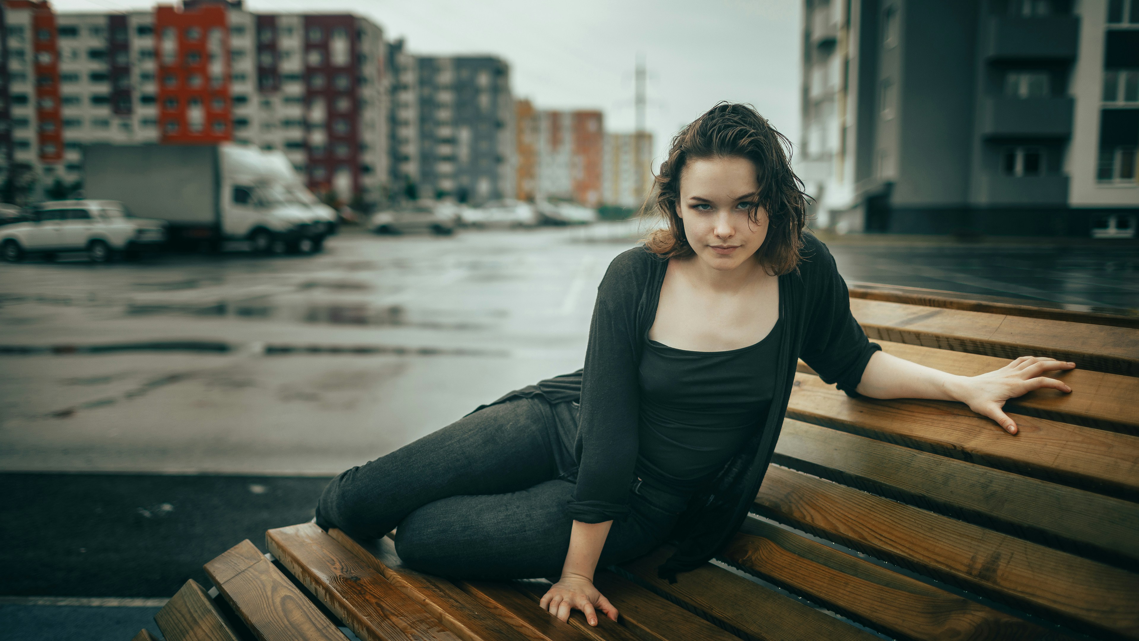 Quiet Gaze on a Rain-Washed City Bench
