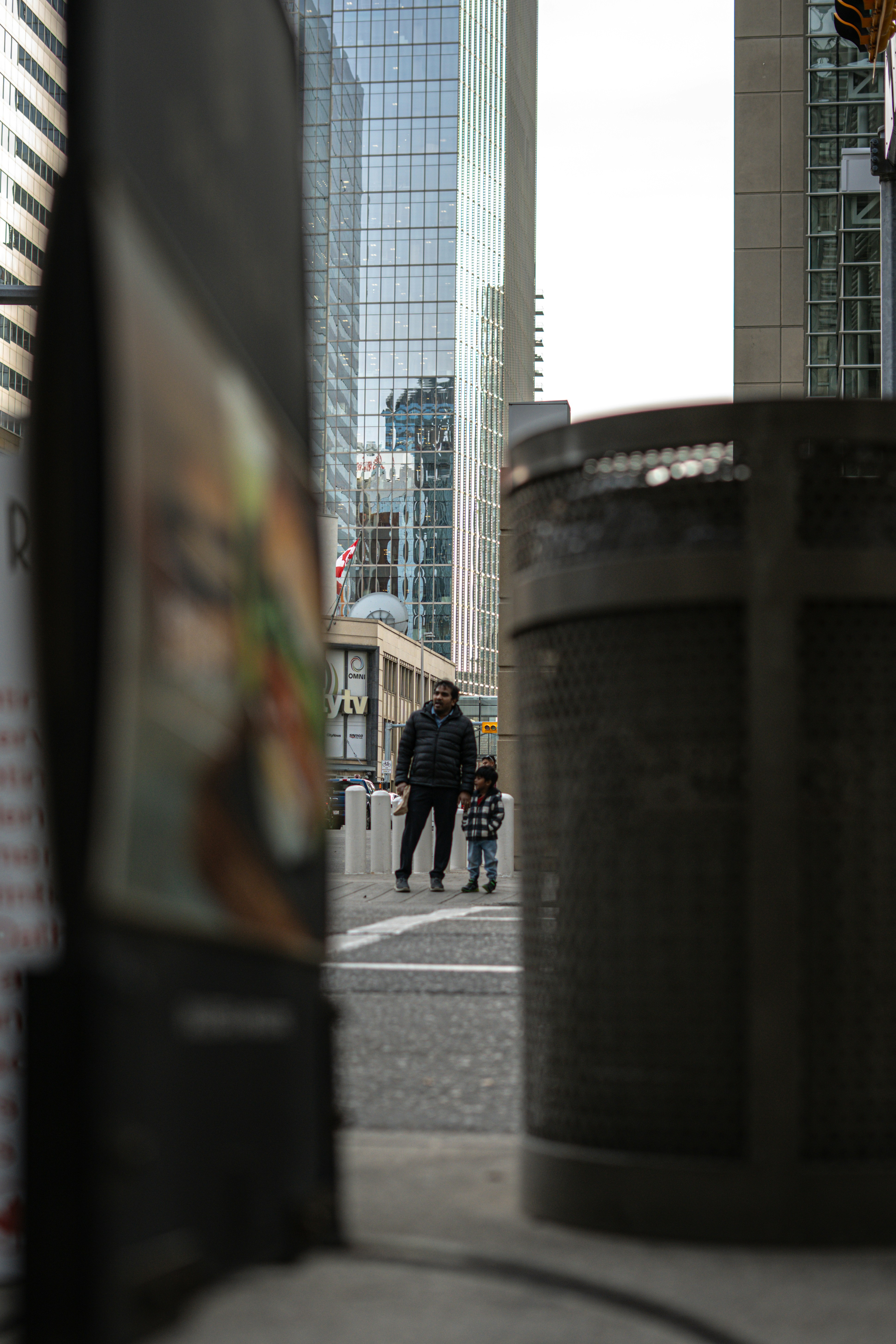 Midtown Moment: A Father and Child Crossing the City's Reflective Street