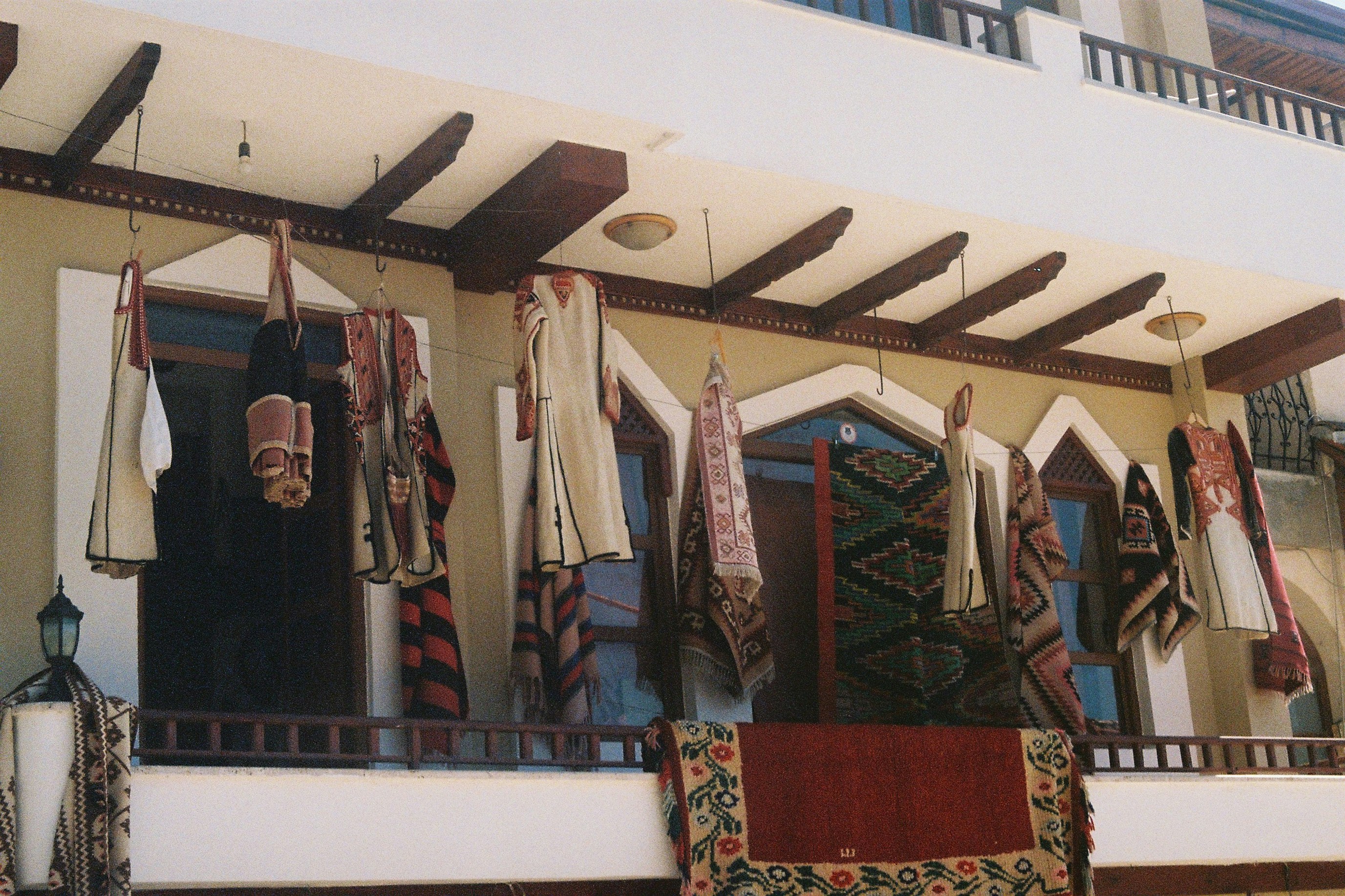 Textiles and rugs hanging outside a building