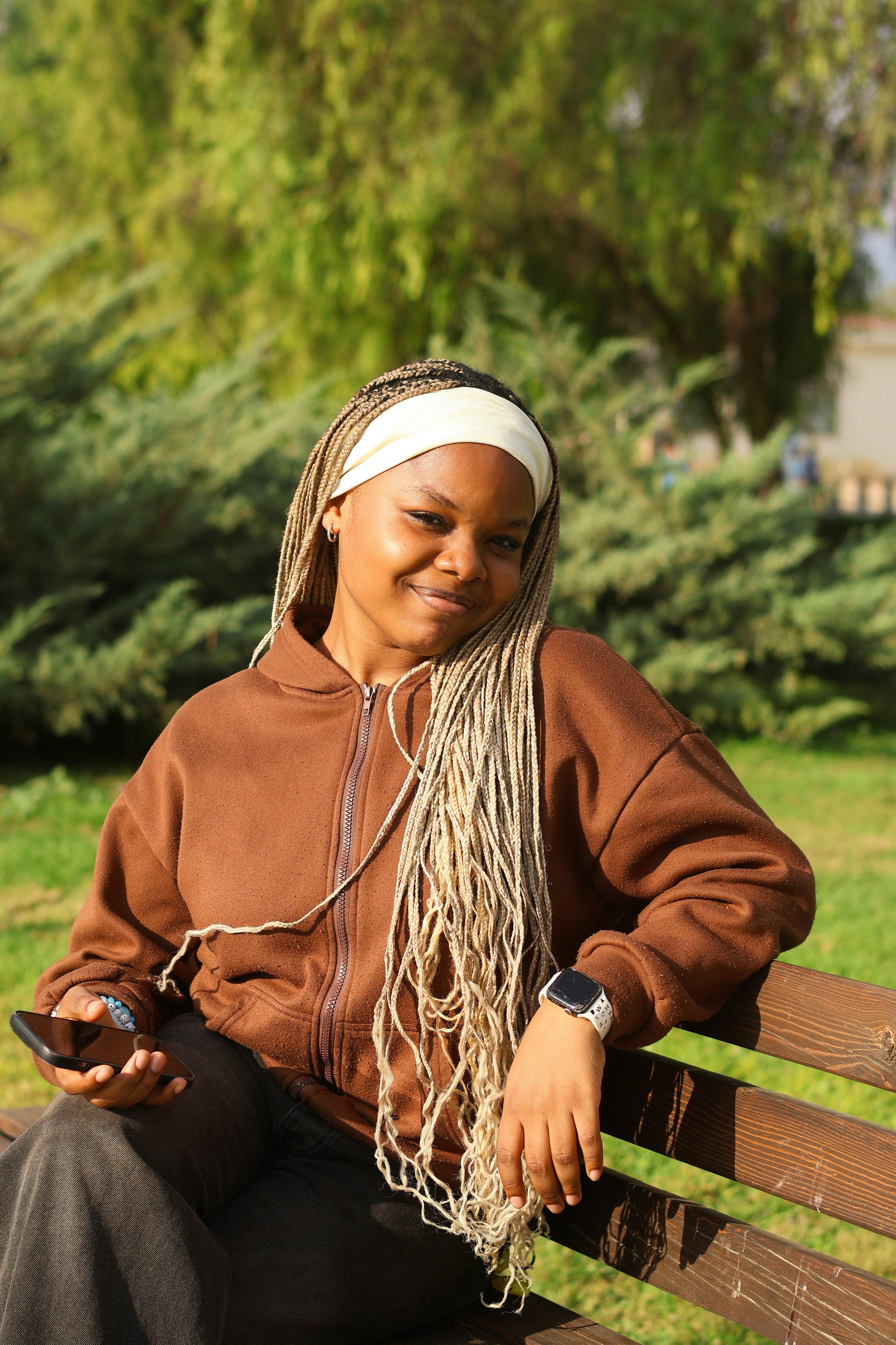 Braids in the Sun: A Park Bench Portrait of Quiet Confidence