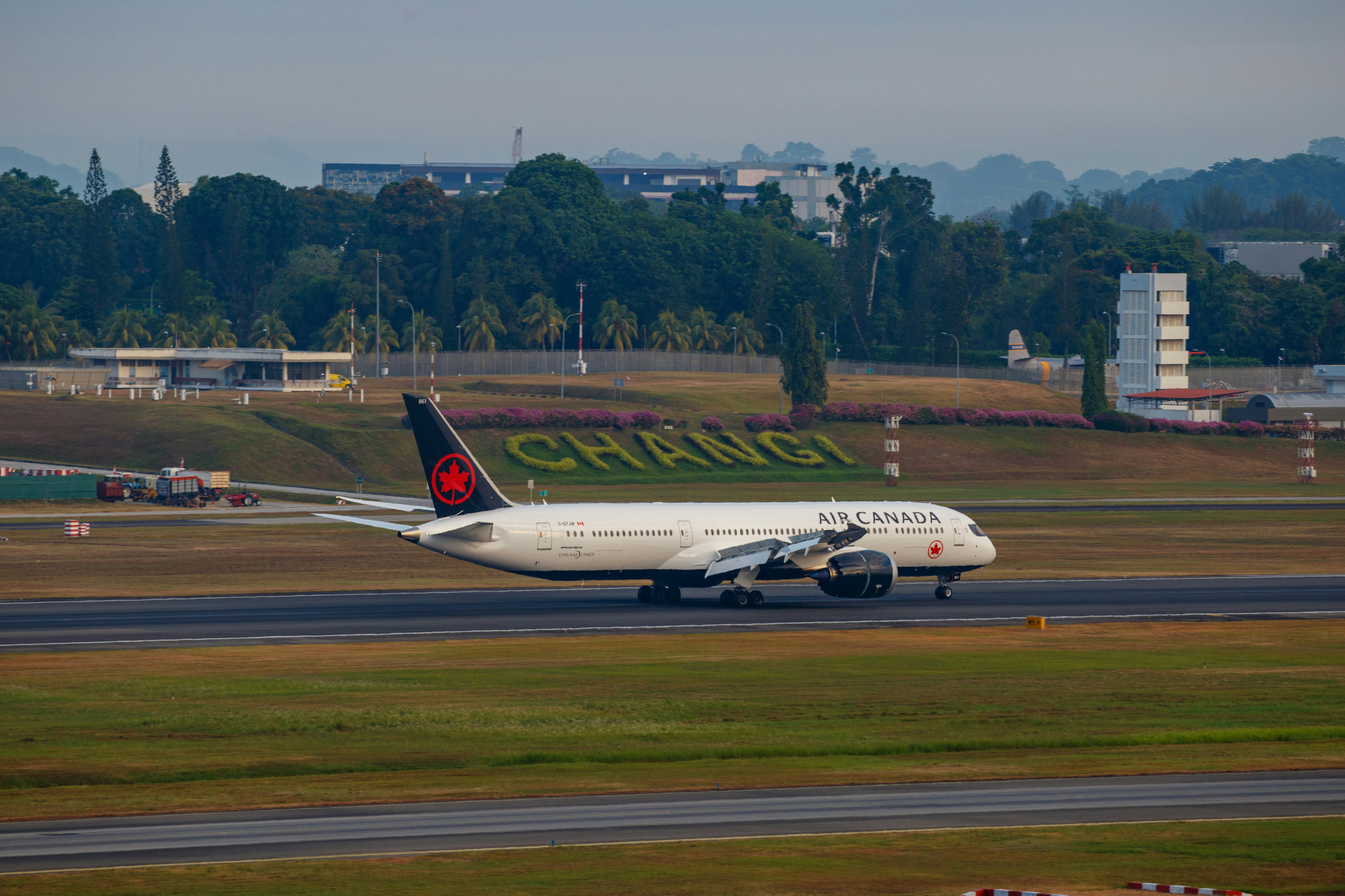 Air Canada taxiing to the runway under a calm, sunlit sky