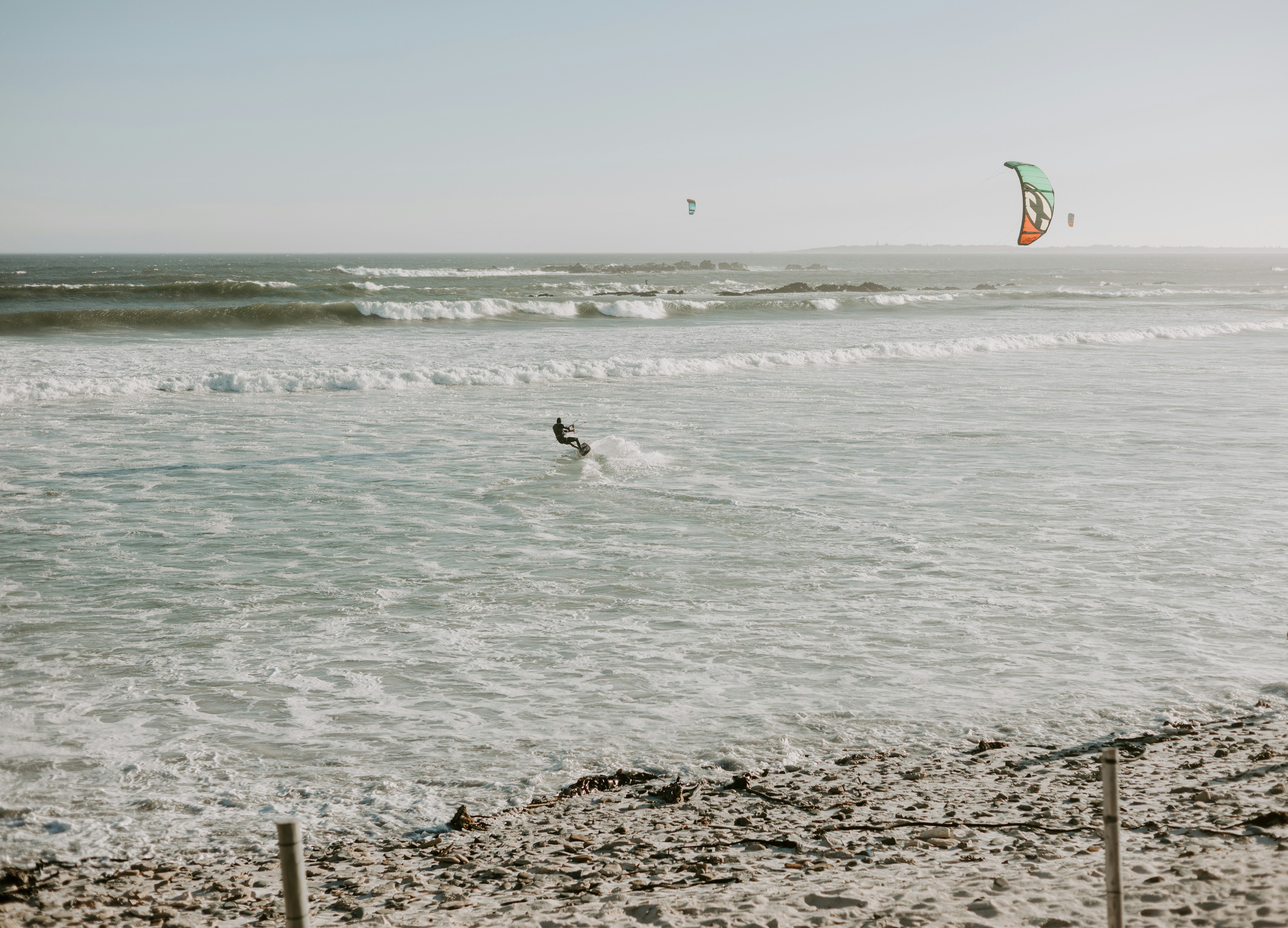 Two Kite Surfers Carve Quiet Arcs Over a Calm Atlantic