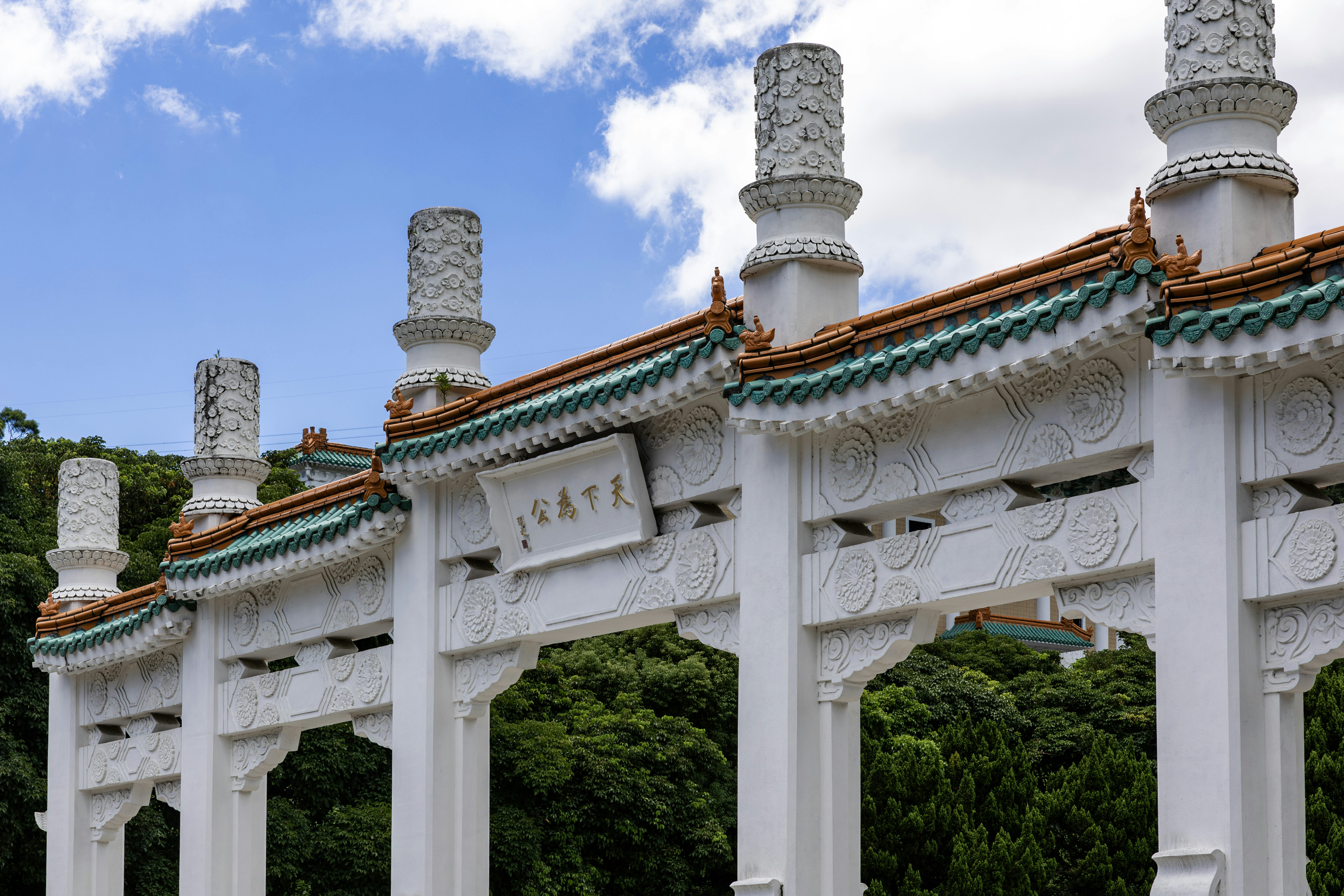 Jade-Tiled Gate: White Arches Framing a Tranquil Garden Corridor