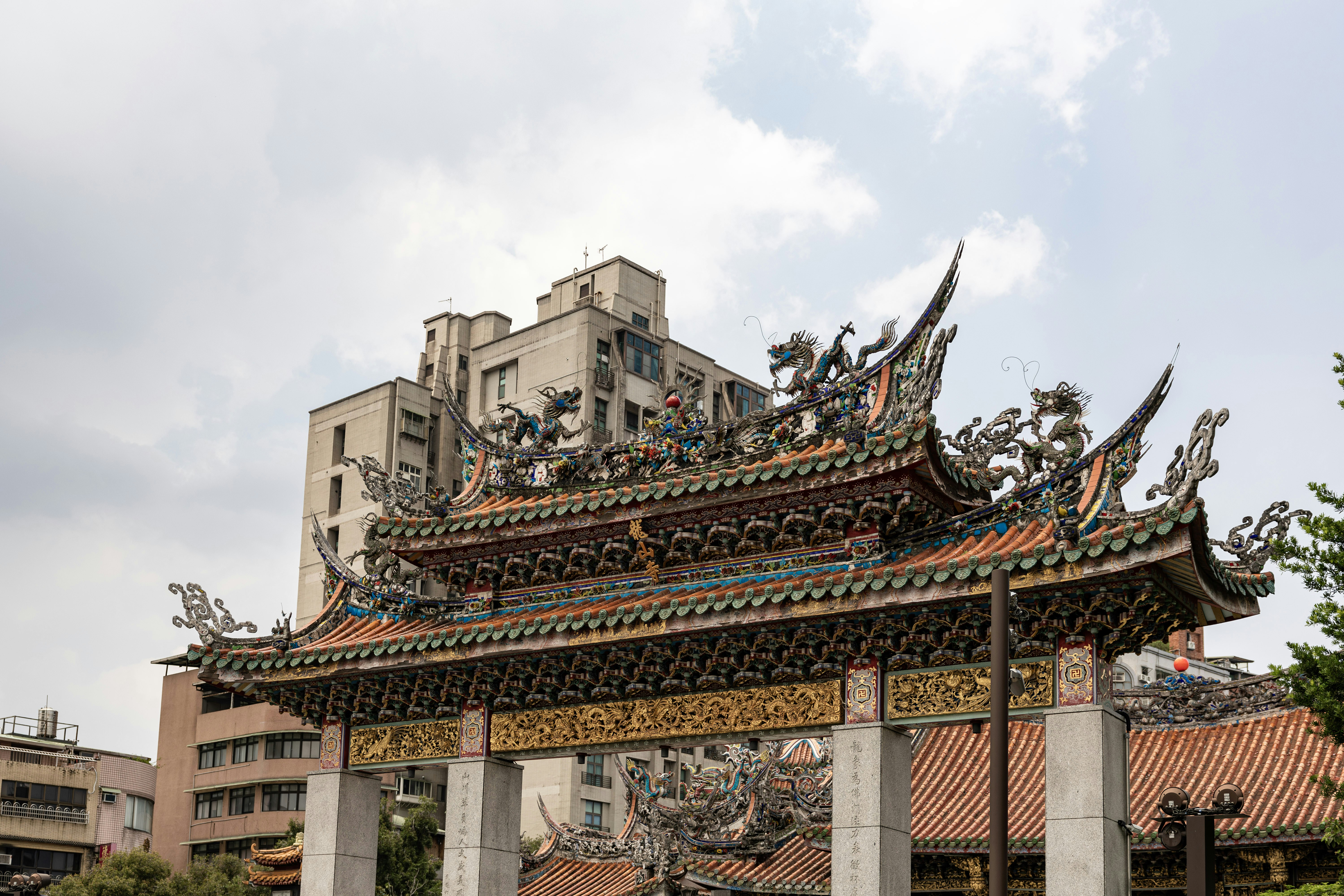 Dragon-Crest Gateway Between Eras: Temple Gate Meets City Blocks