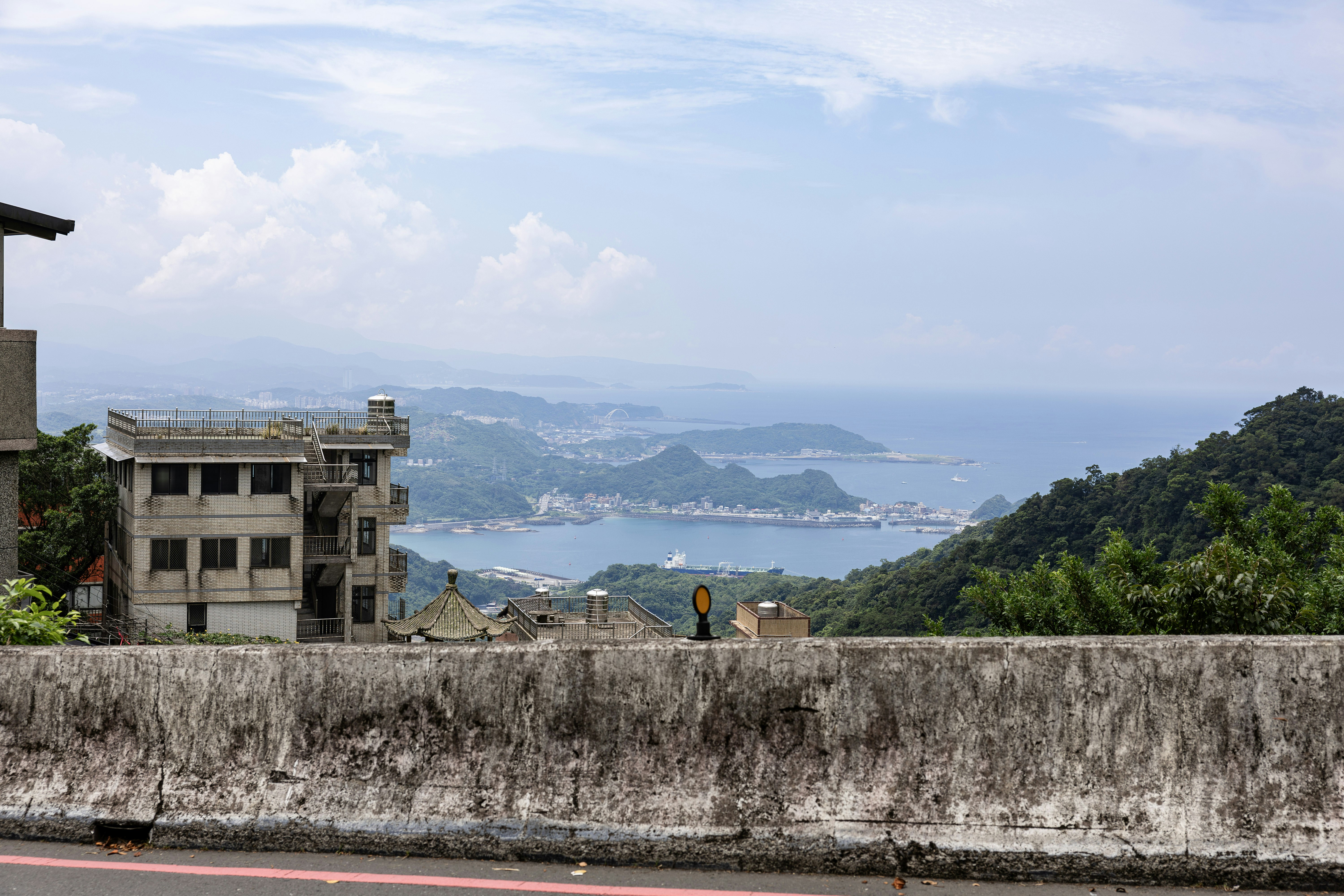 Harbor Ridge Overlook: Weathered Barrier Framing a Quiet Bay
