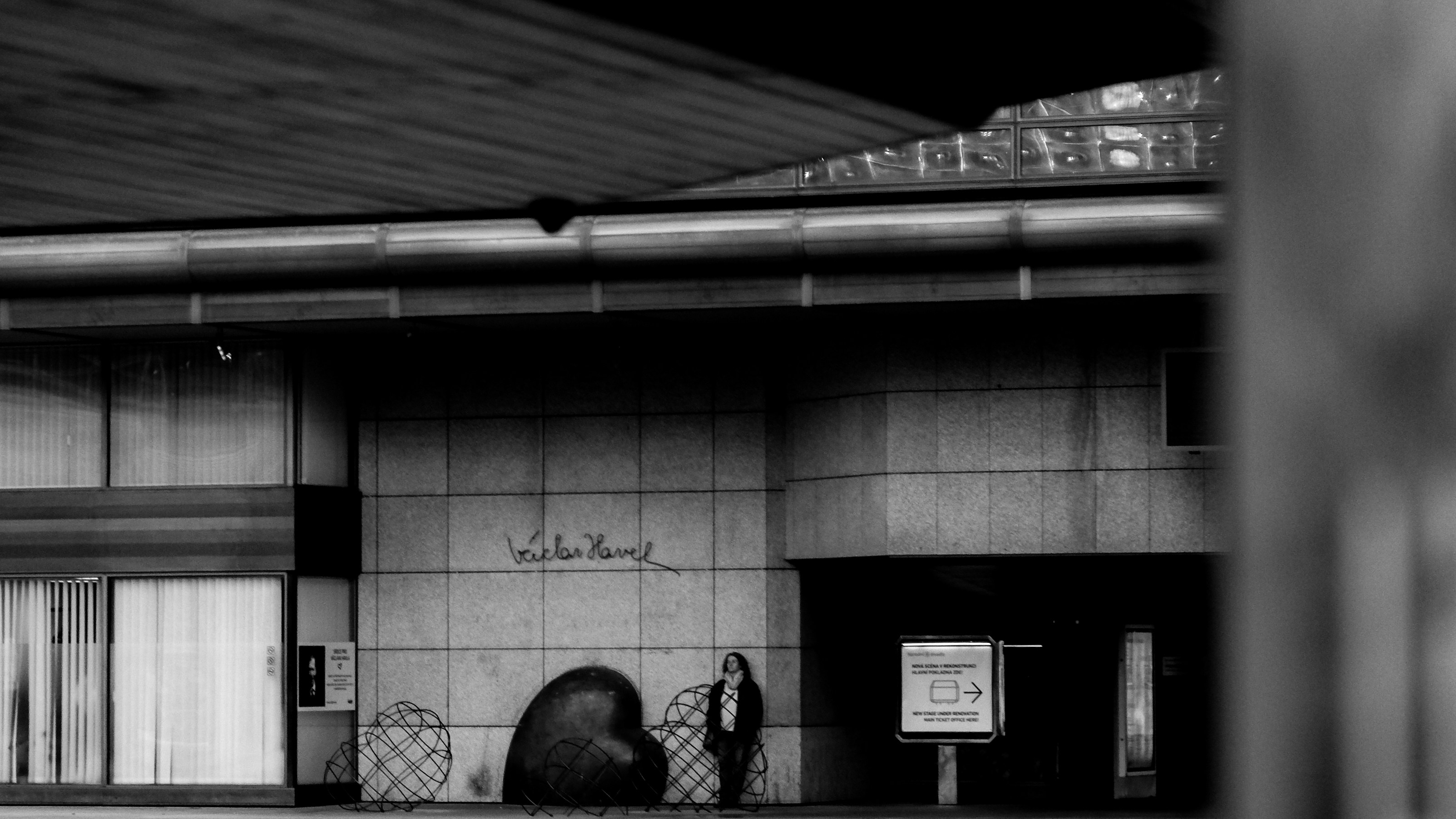 A lone figure stands near a large, dark object. photo – Free Sculpture ...