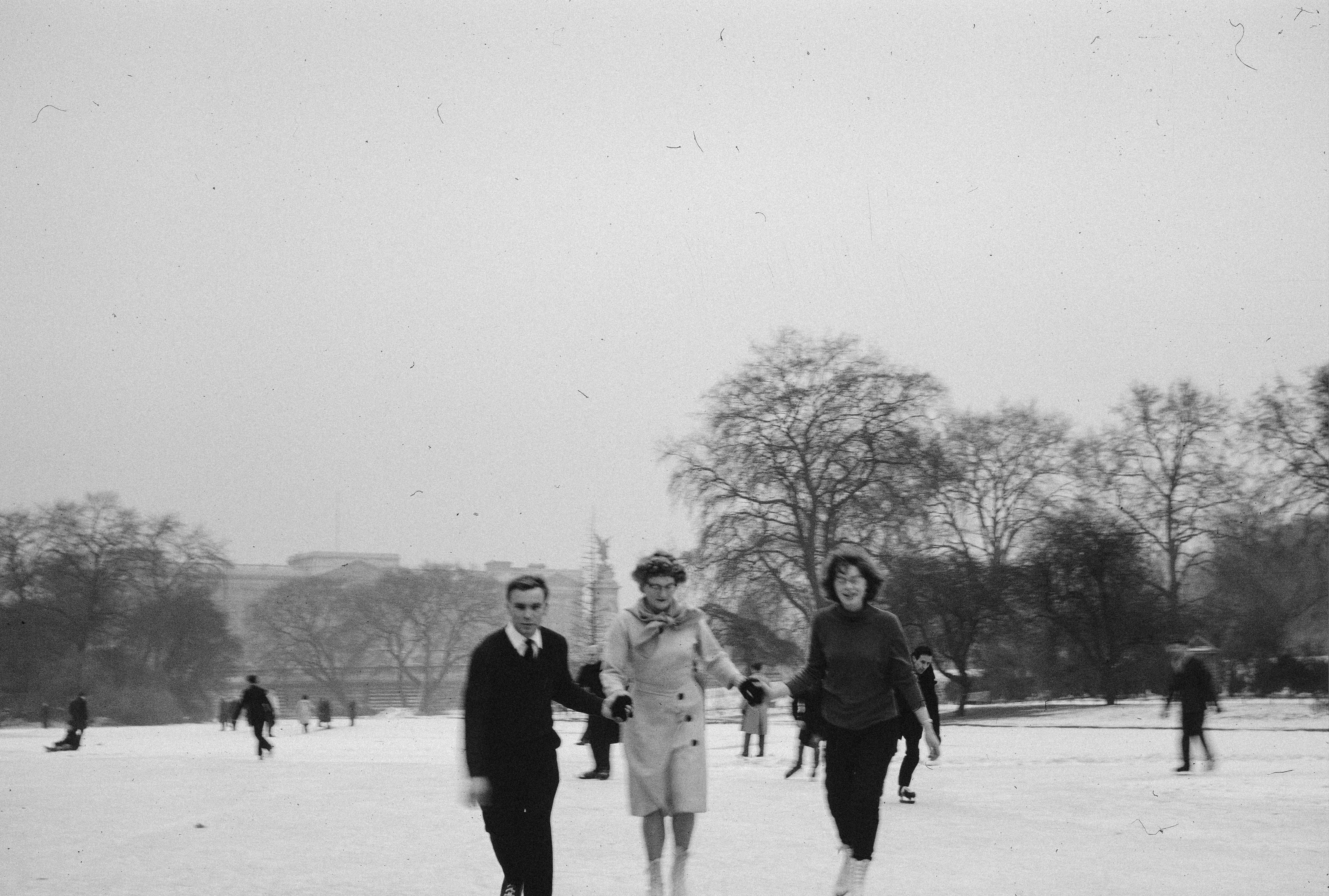 Three Figures on a Snow-Covered Park: A Quiet Winter Moment