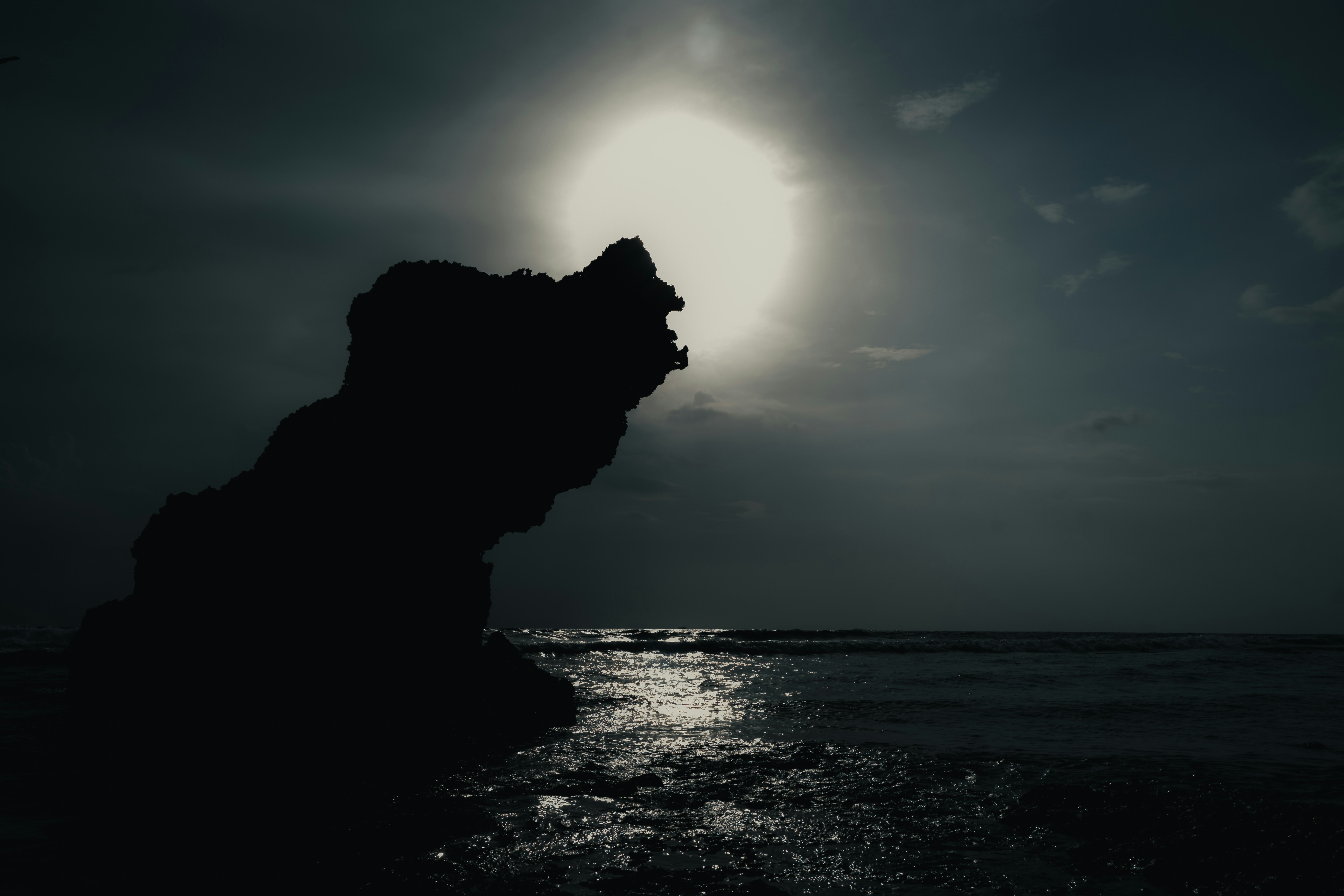 Silhouette at Dusk: A Rockiform Outcrop Meeting the Sea