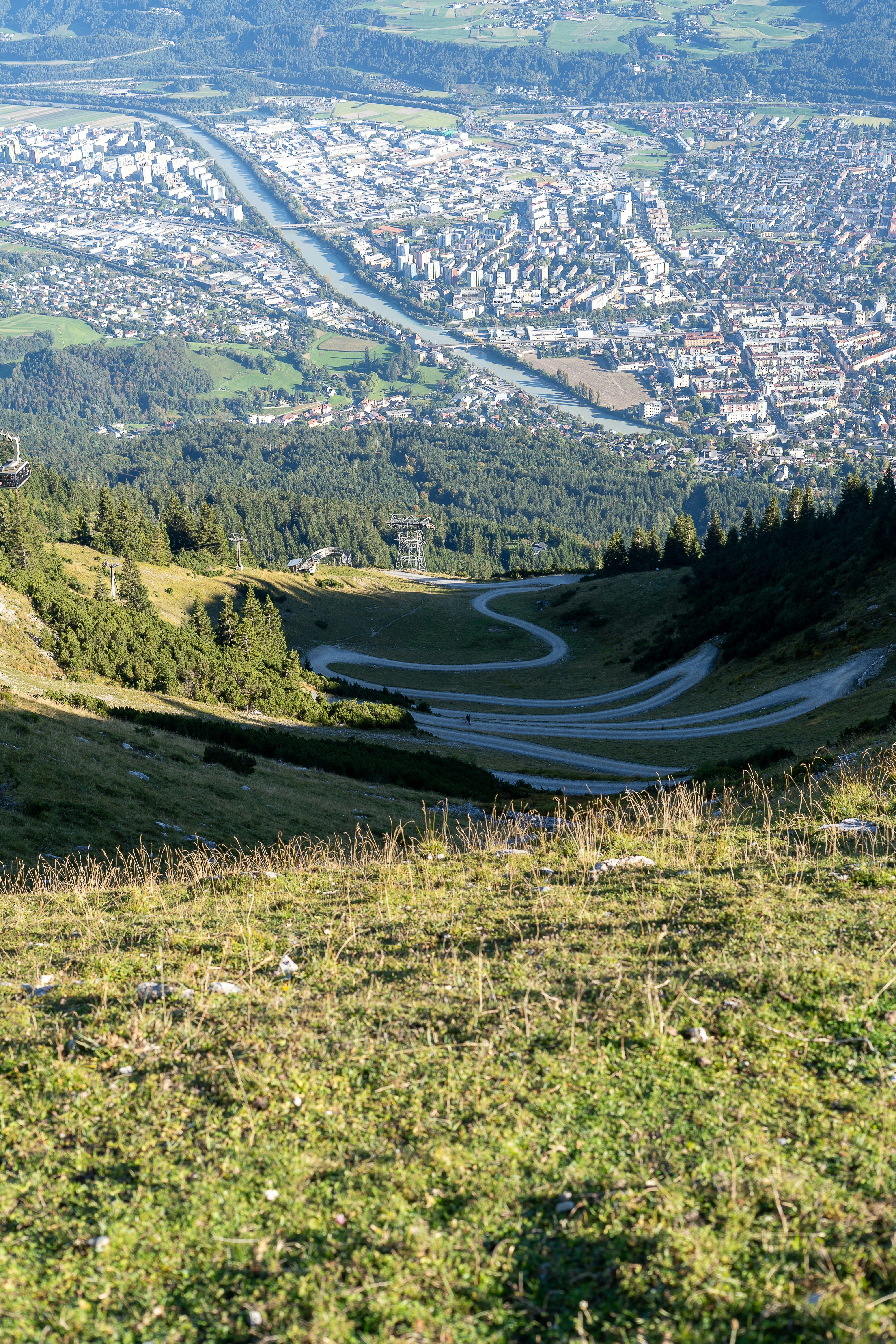 Serpentine Mountain Road Descends into a Riverside Valley