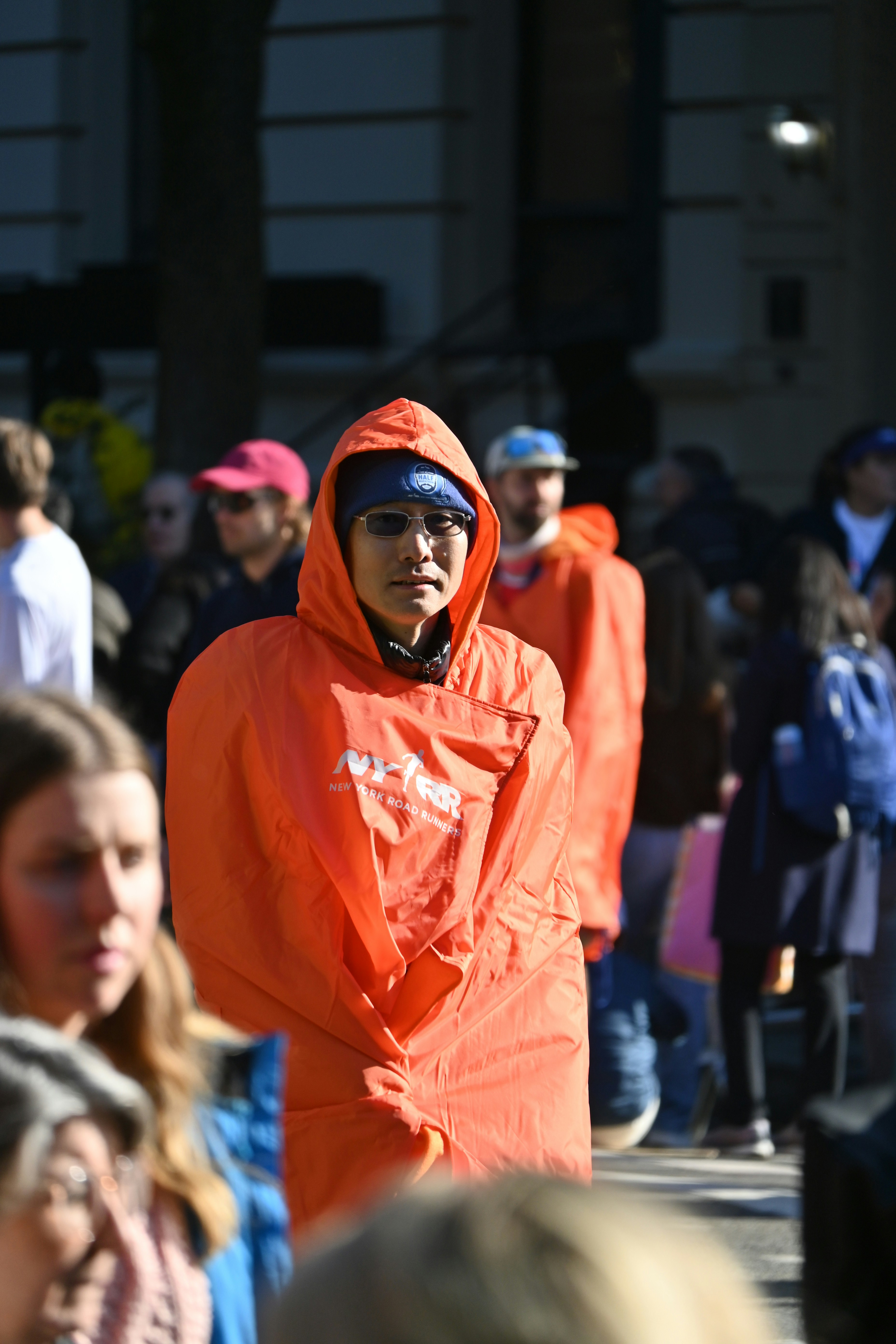 Crimson Hood Amid the City Crowd: A Portrait of Focus