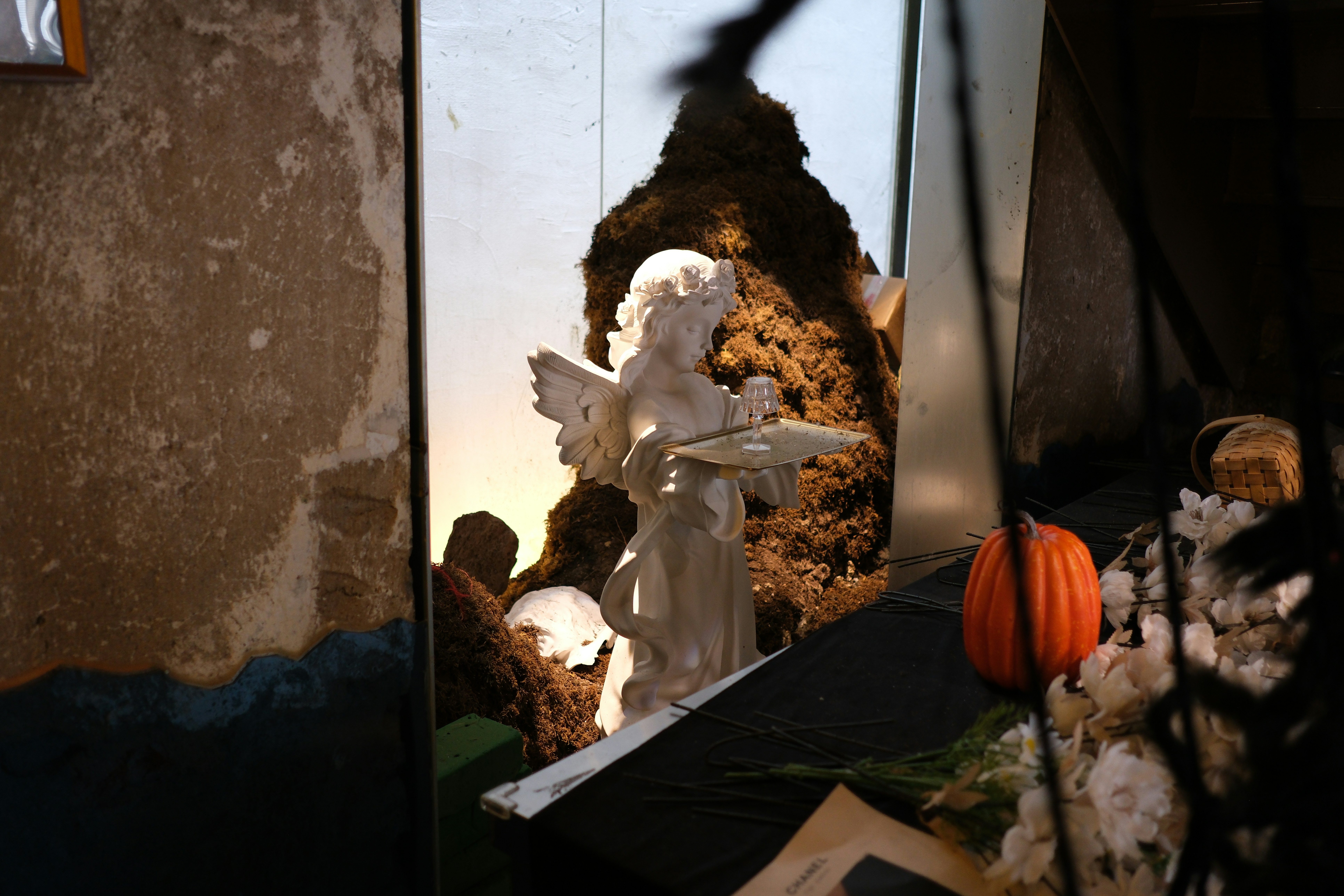 Cherub in a Glass Display Bathed in Warm Backlight