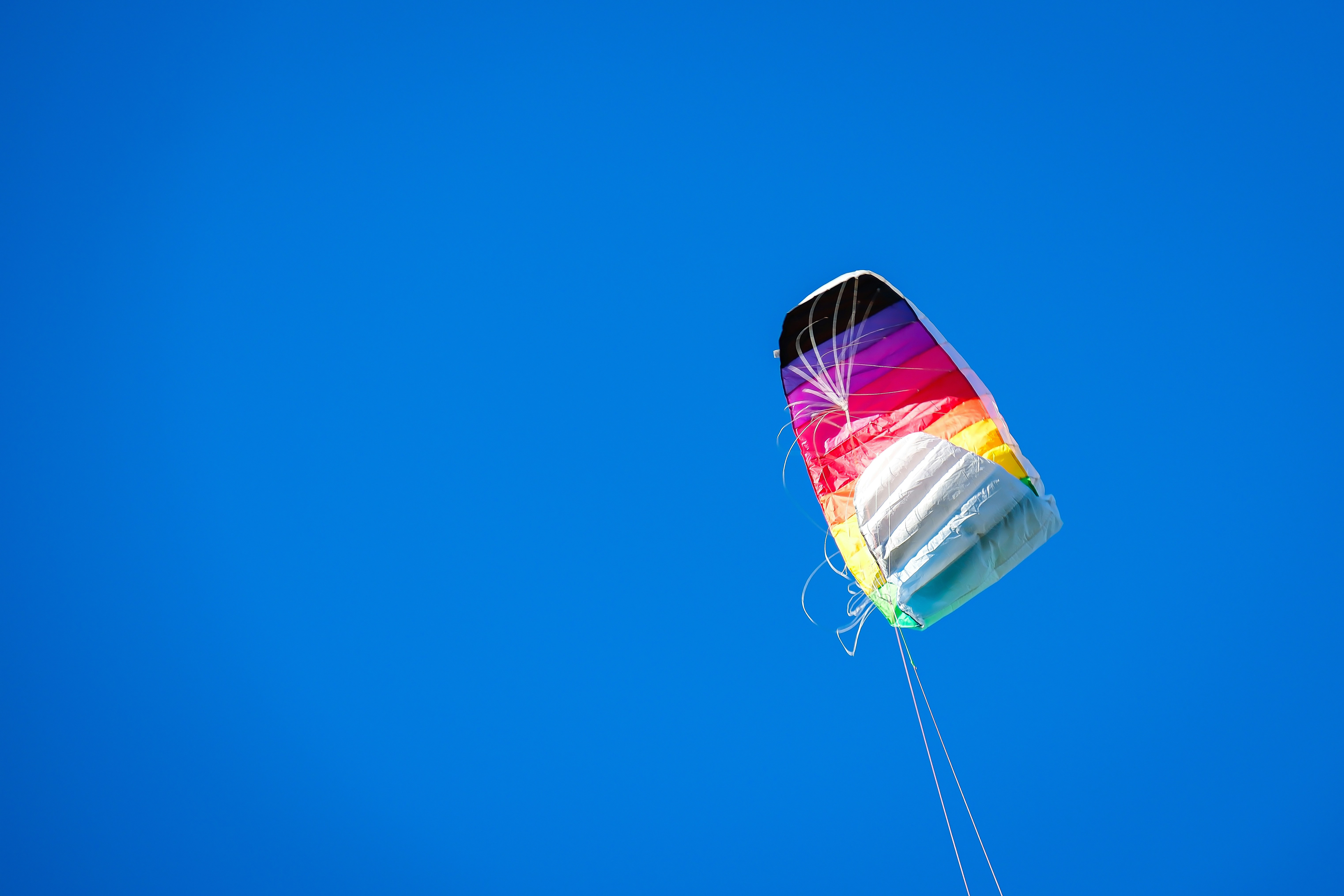 Prismatic Kite Skimming a Pristine Blue Expanse