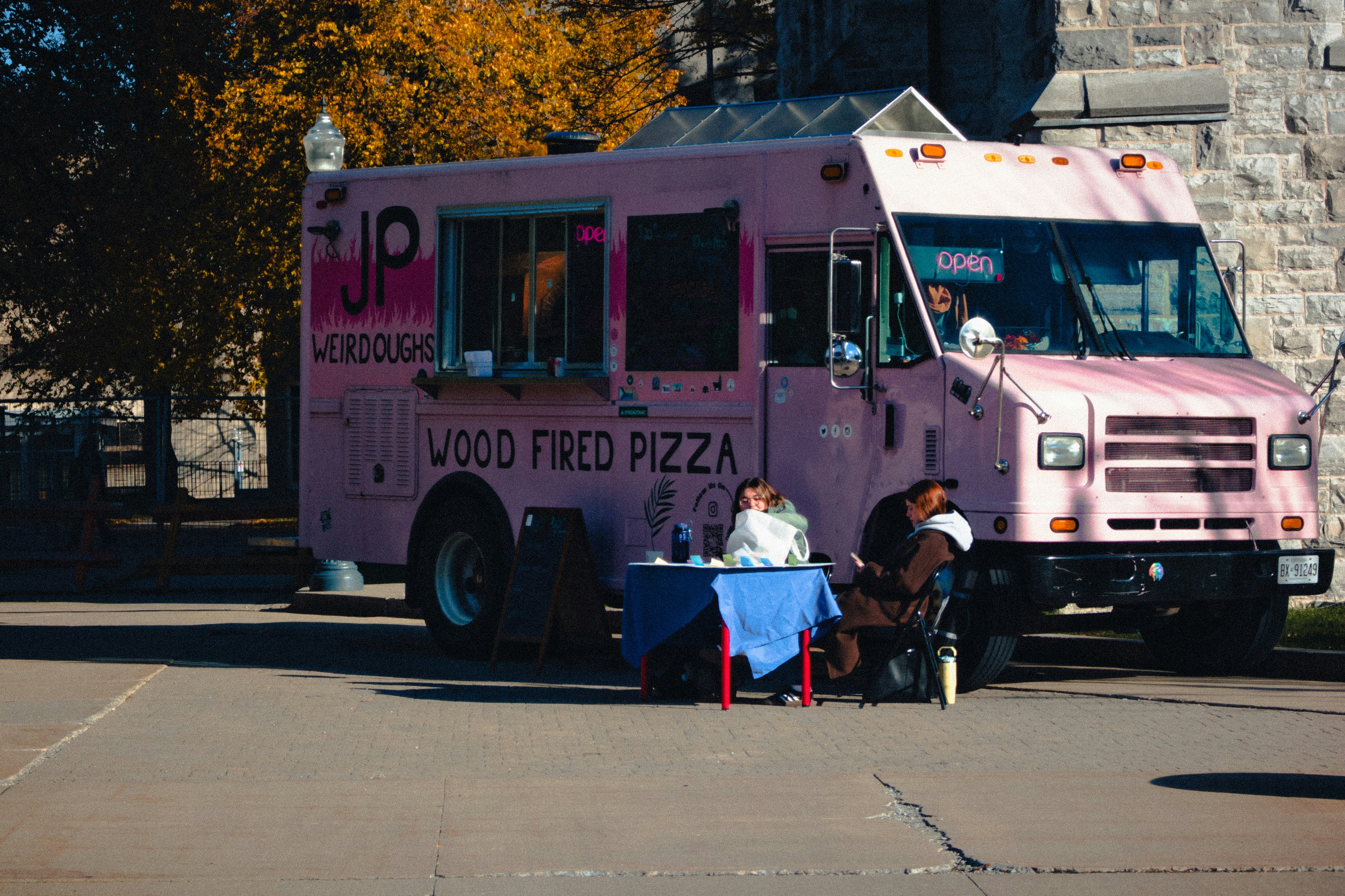 The Pink Wood-Fired Pizza Van Beneath Autumn-Gilded Trees