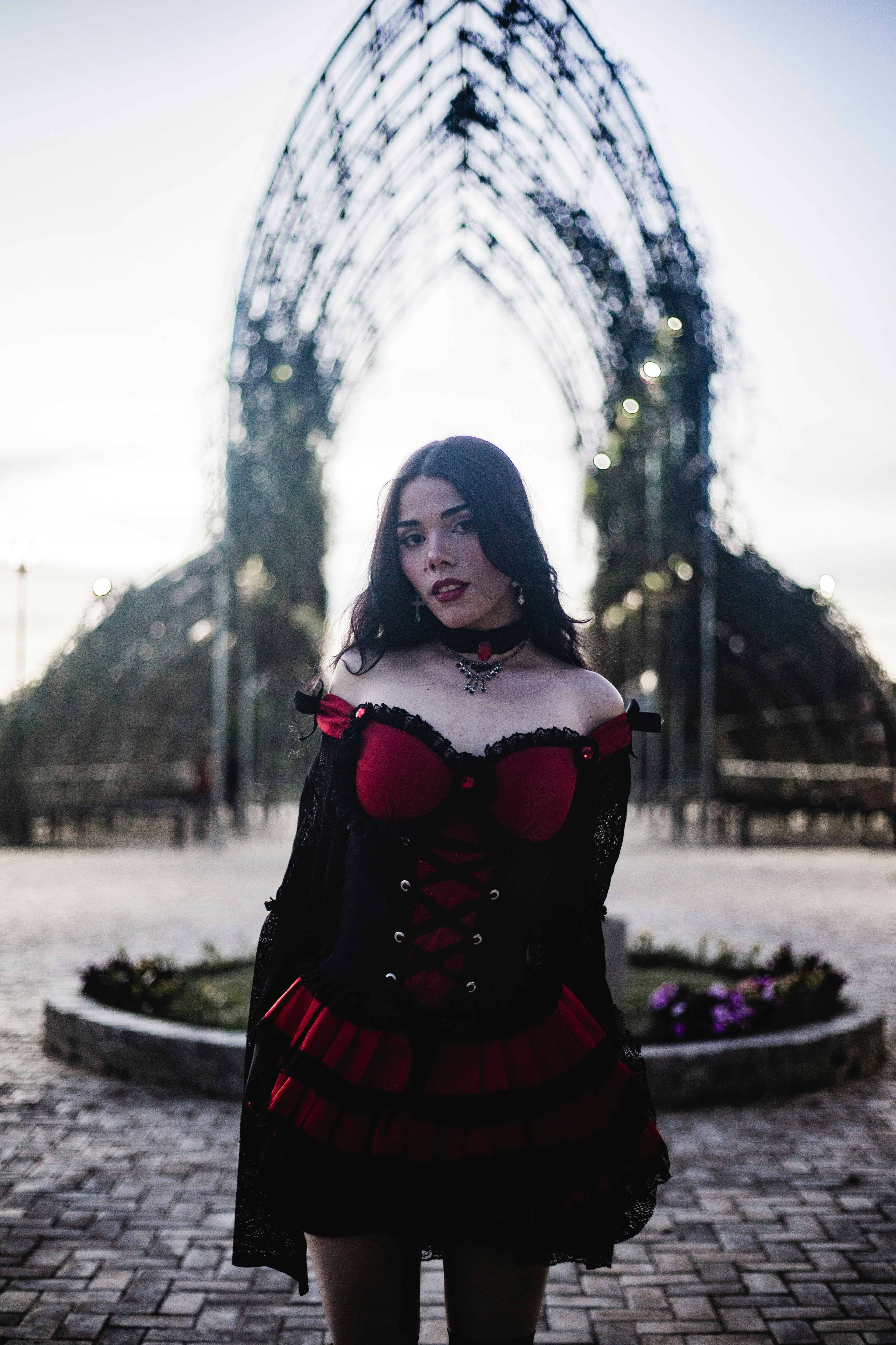 Crimson Corset Beneath the Wrought-Iron Arch