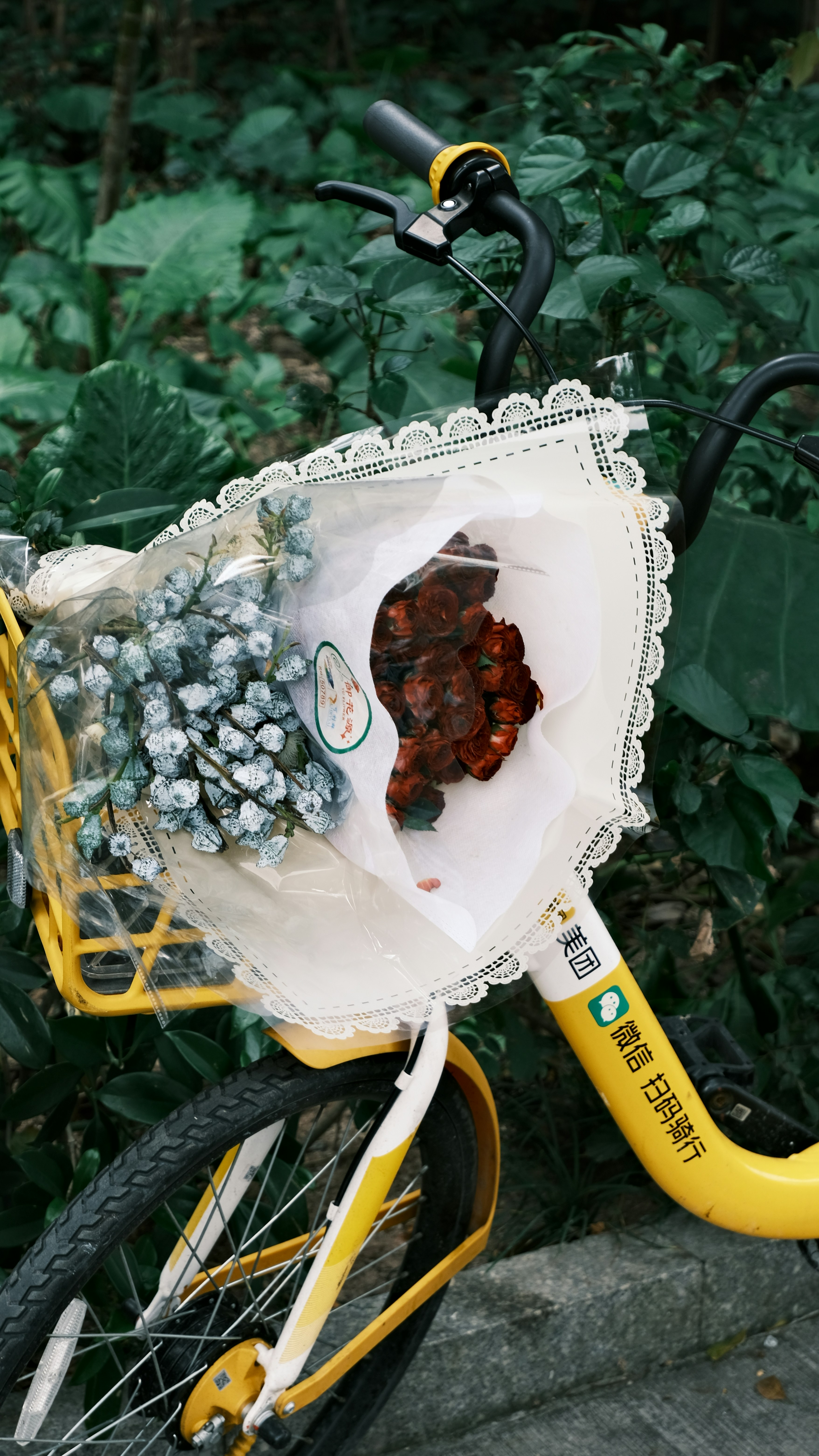 Bouquet in Lace on a Yellow Bicycle Surrounded by Greenery