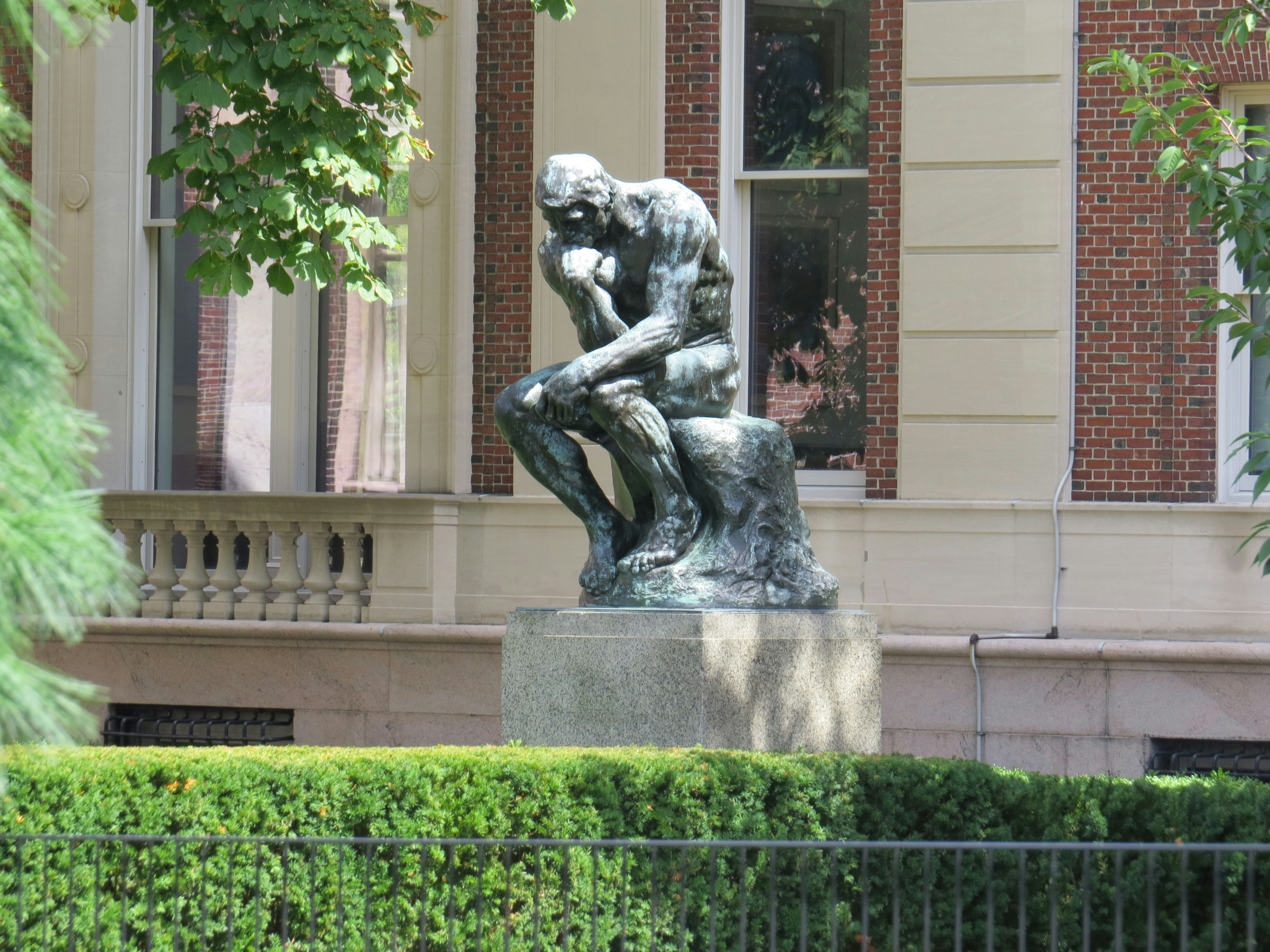 Bronze Thinker in a Sunlit Campus Courtyard