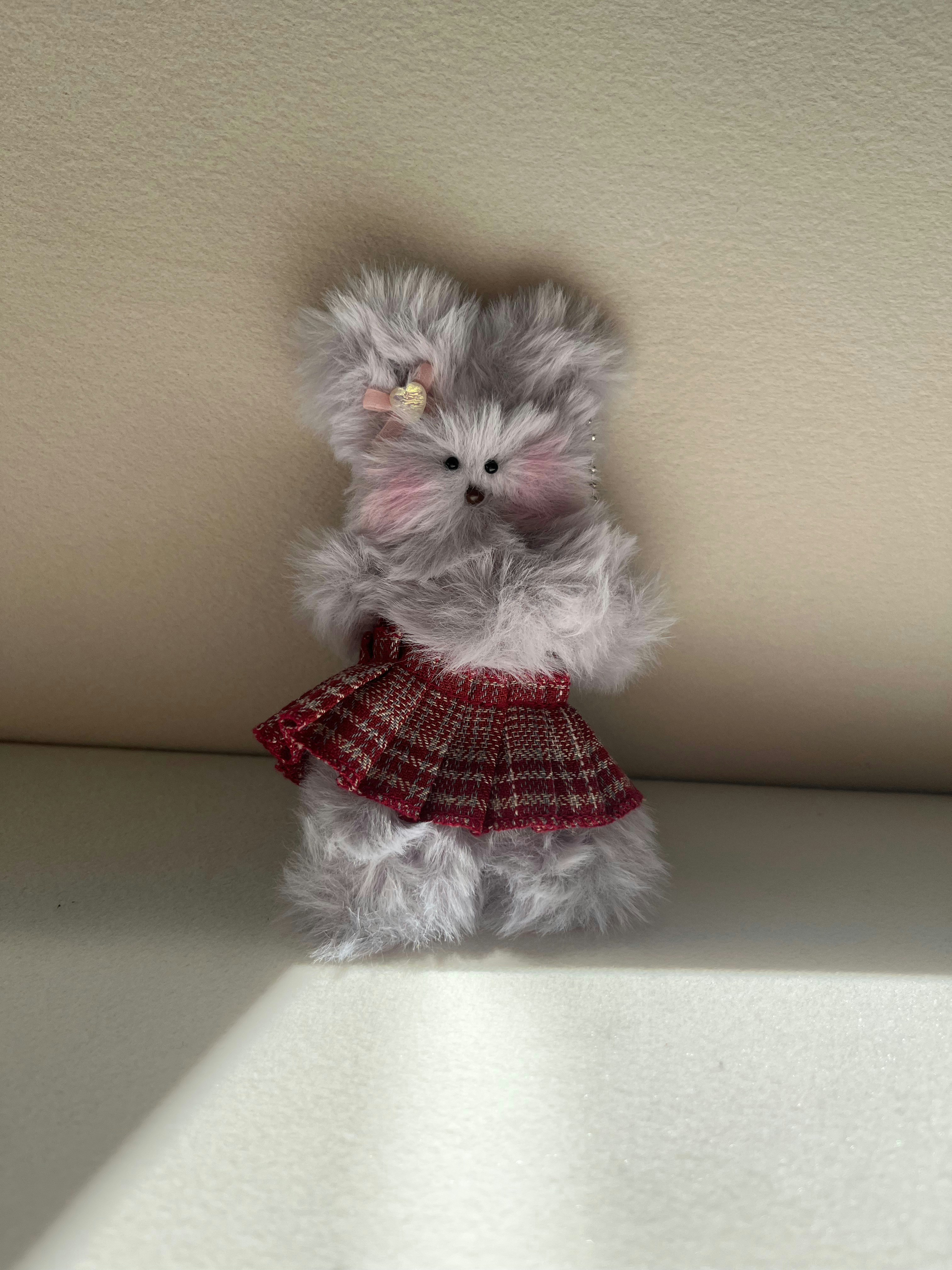 Velvet Bunny in a Red Plaid Dress Stands on a Quiet Windowsill