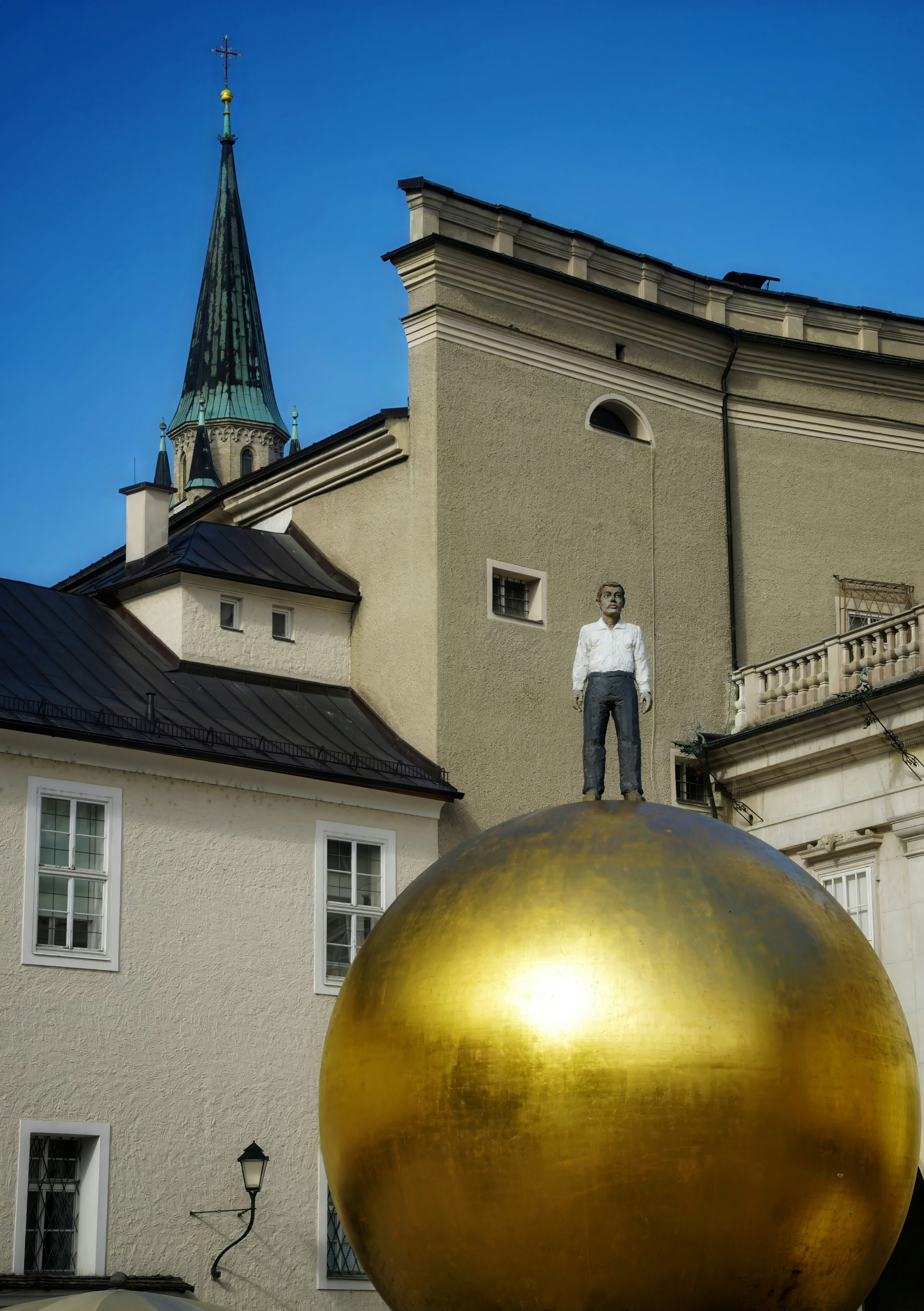Man stands on golden sphere with church spire photo – Free Cityscape ...