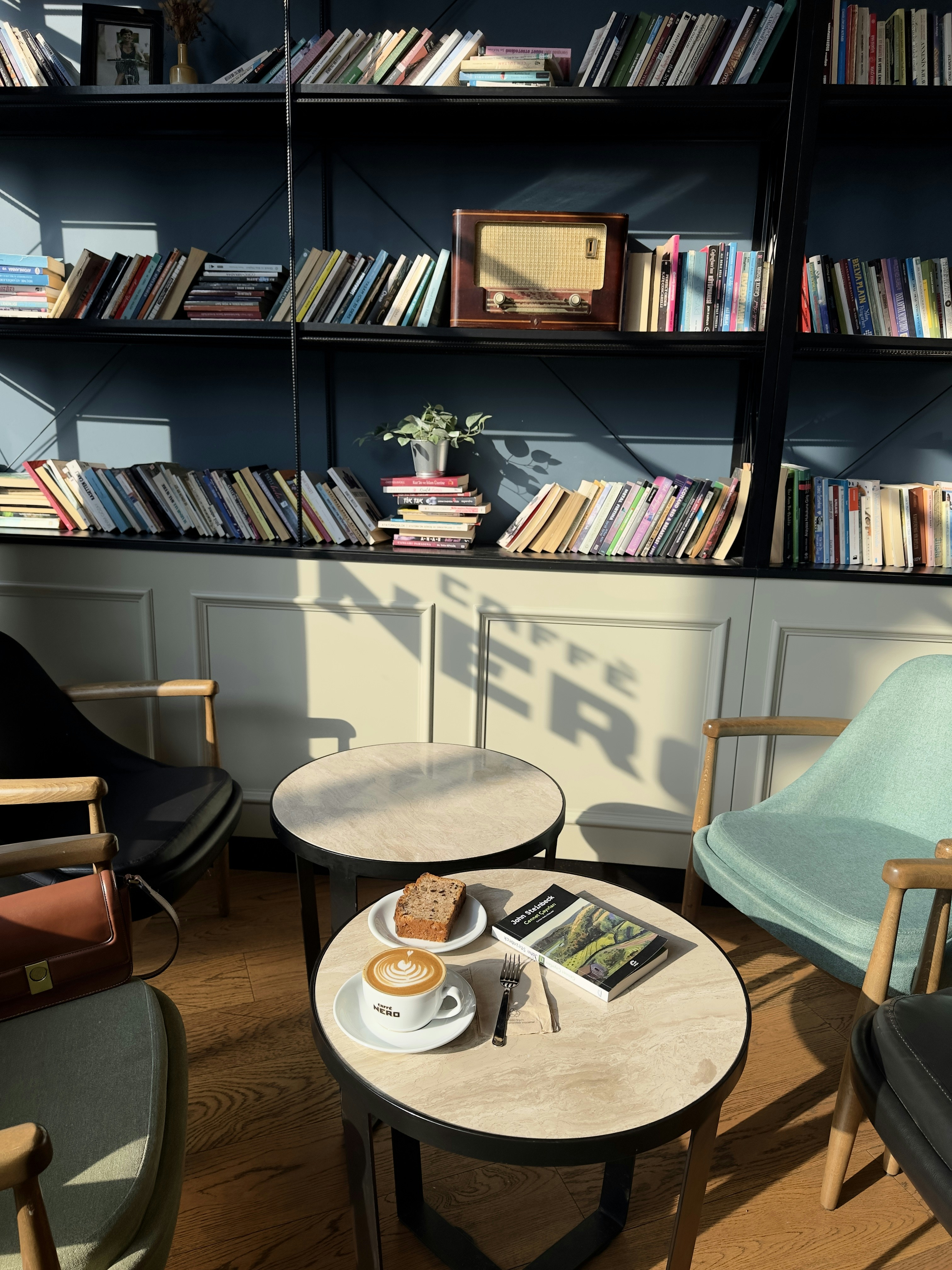 Sunlit Round Table in a Book-lined Nook: Coffee, Cake, and Quiet