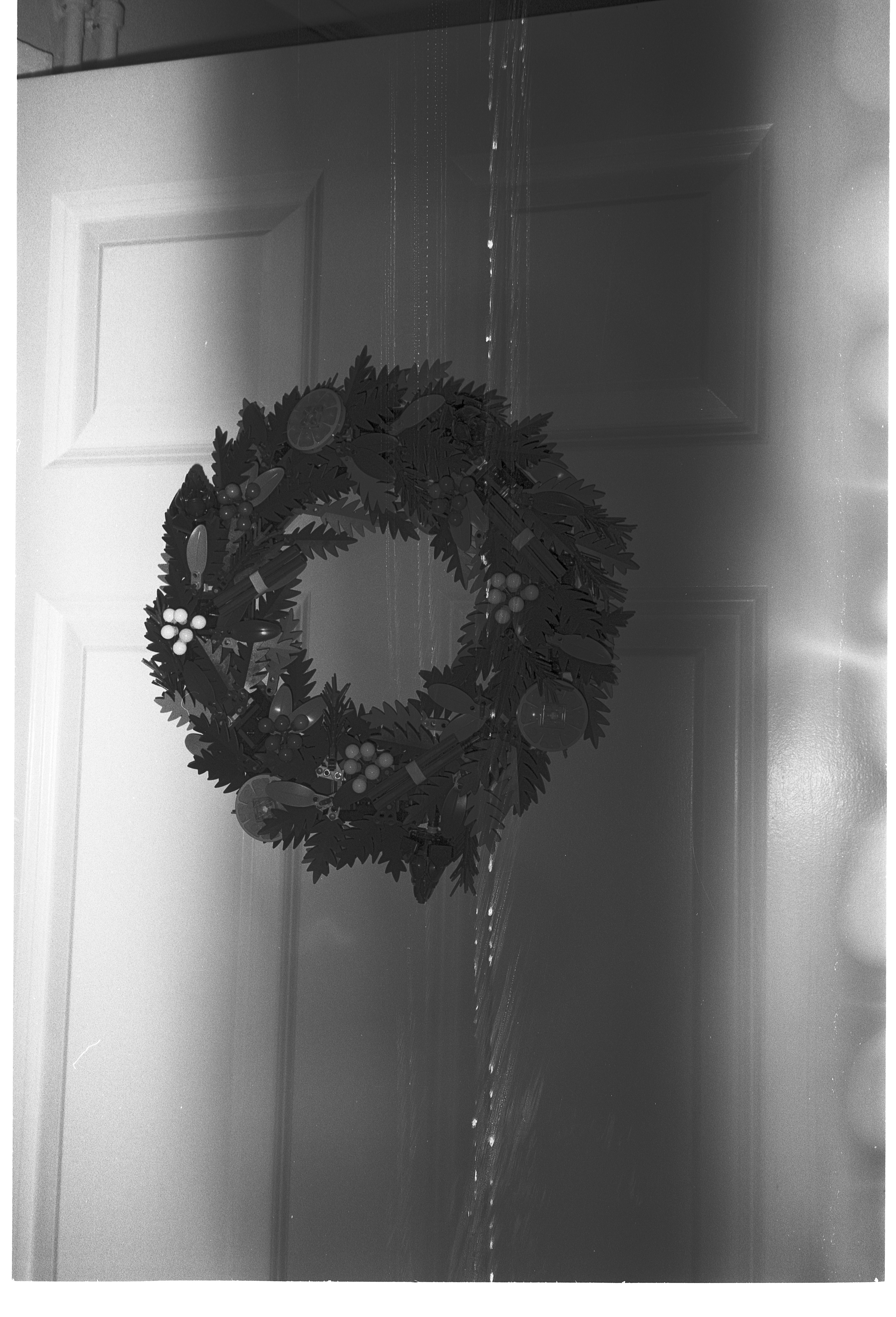 Wreath in Focus: A Quiet Holiday Moment on a Dim Doorway