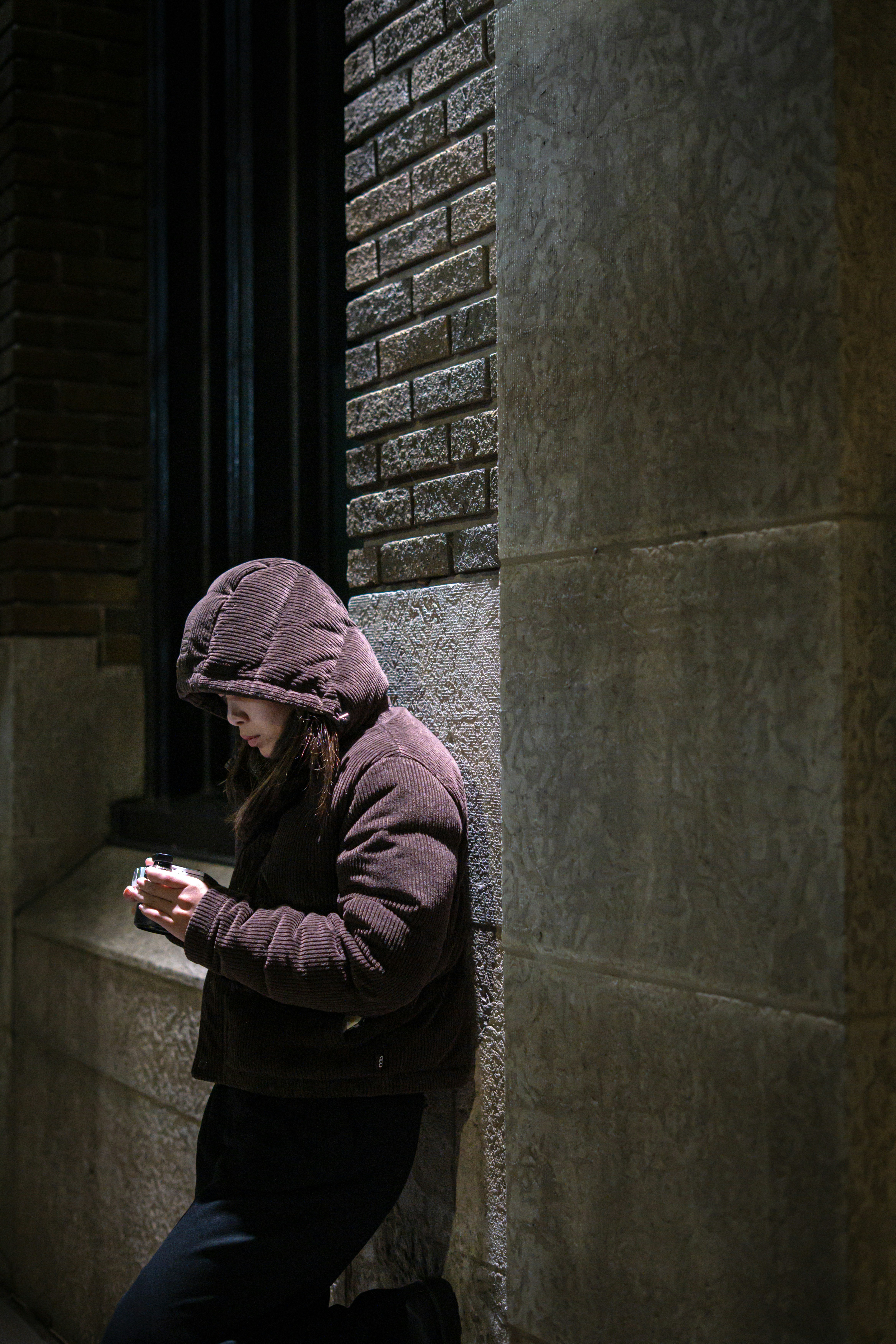 Hooded Focus at the Corner of Night and Brick