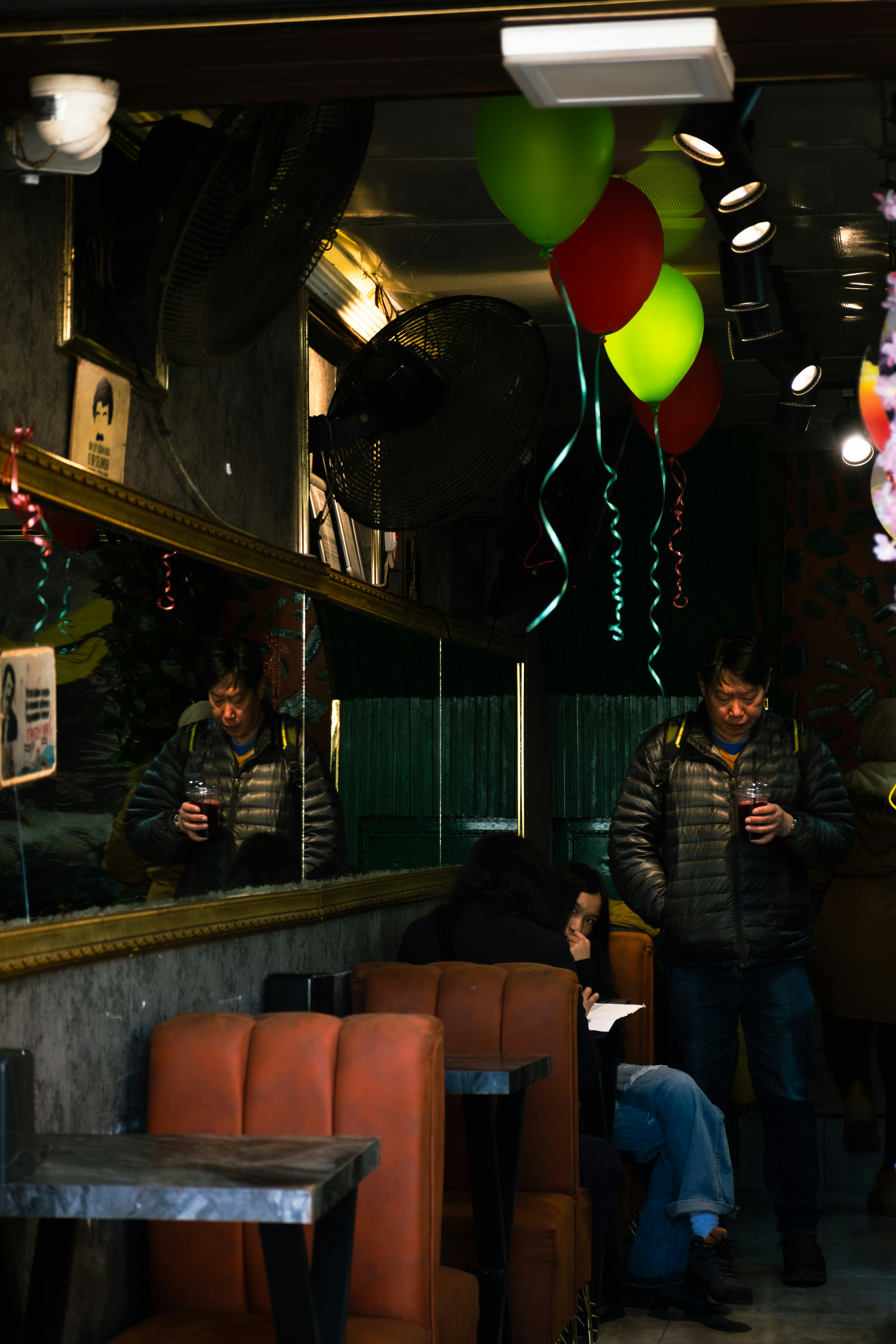 Ballooned Neon Over a Quiet Toast in a Dim Café