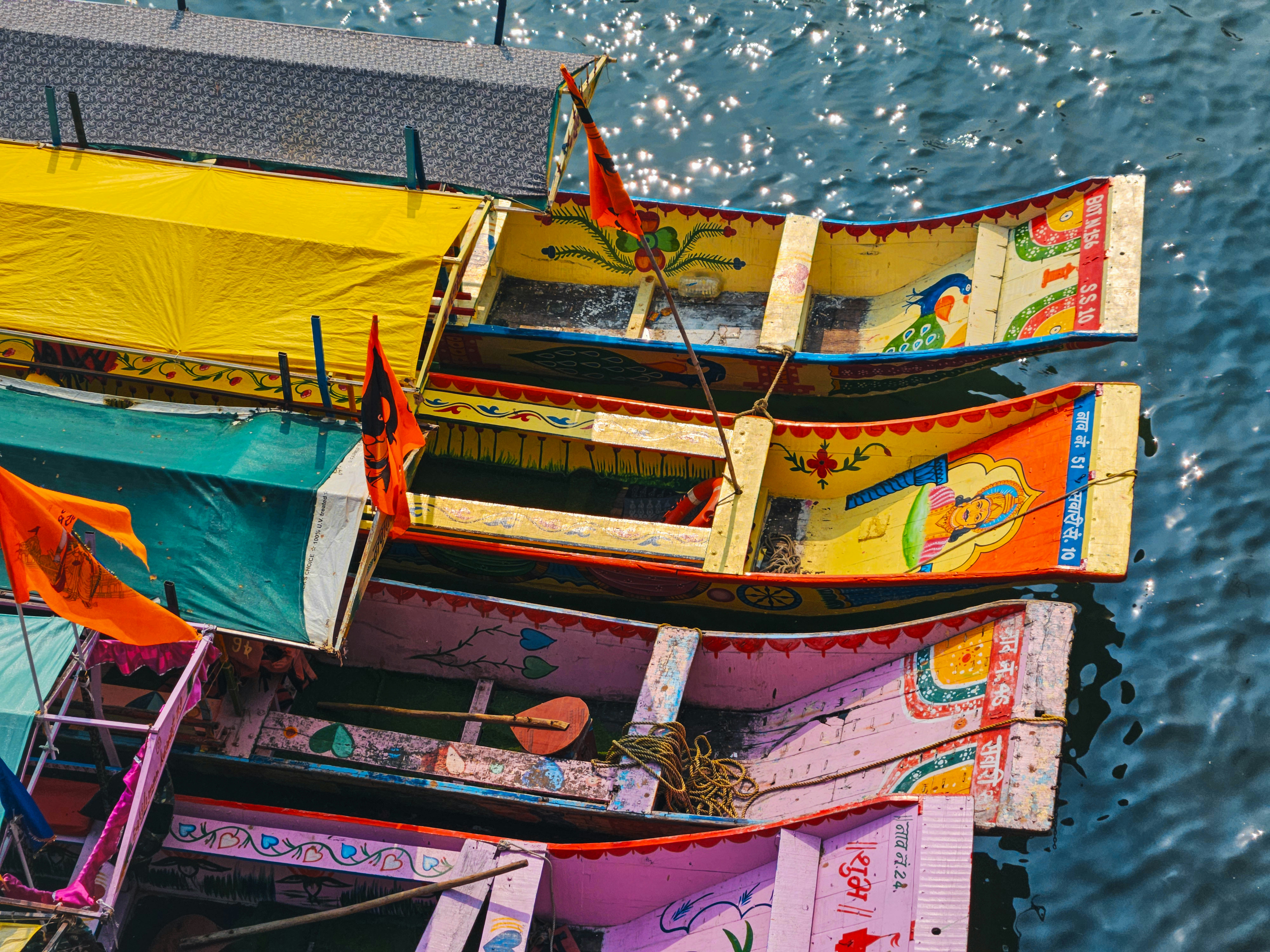 Sunlit Parade of Rainbow Boats on a Calm Sea
