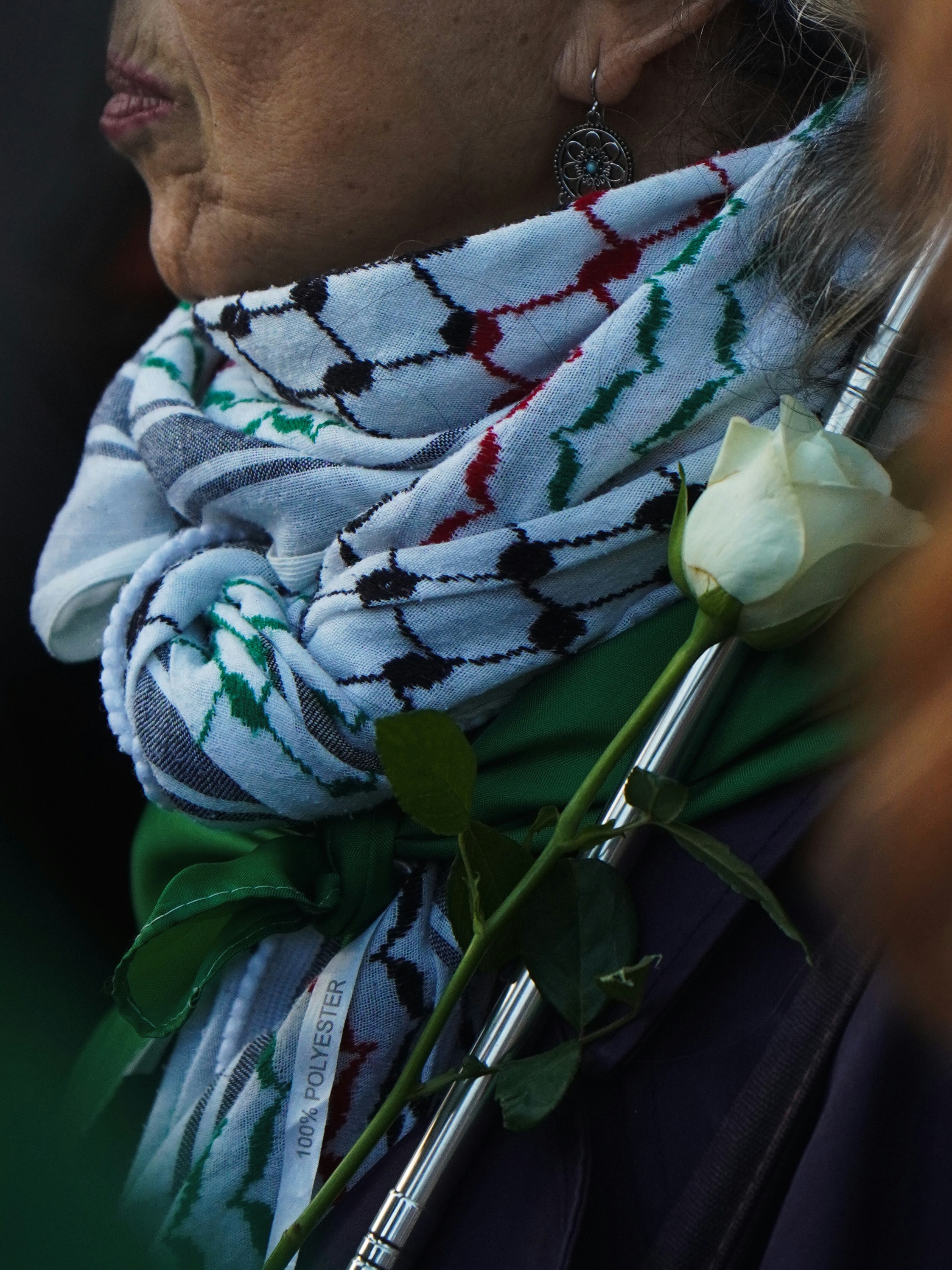 Close-Up Ceremonial: White Rose, Patterned Scarf, and Silver Staff