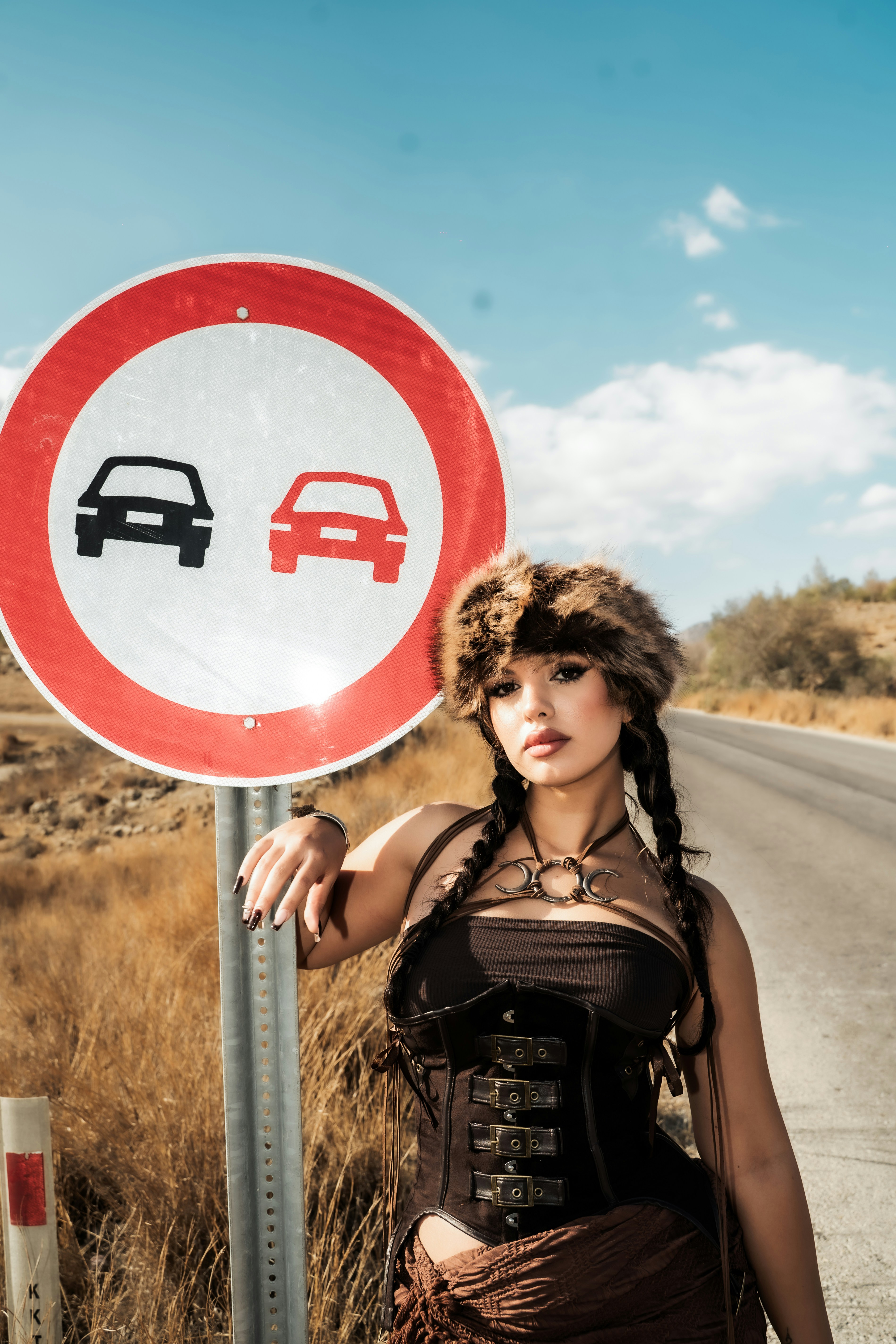 Corseted Nomad by a No-Overtaking Sign on an Open Highway